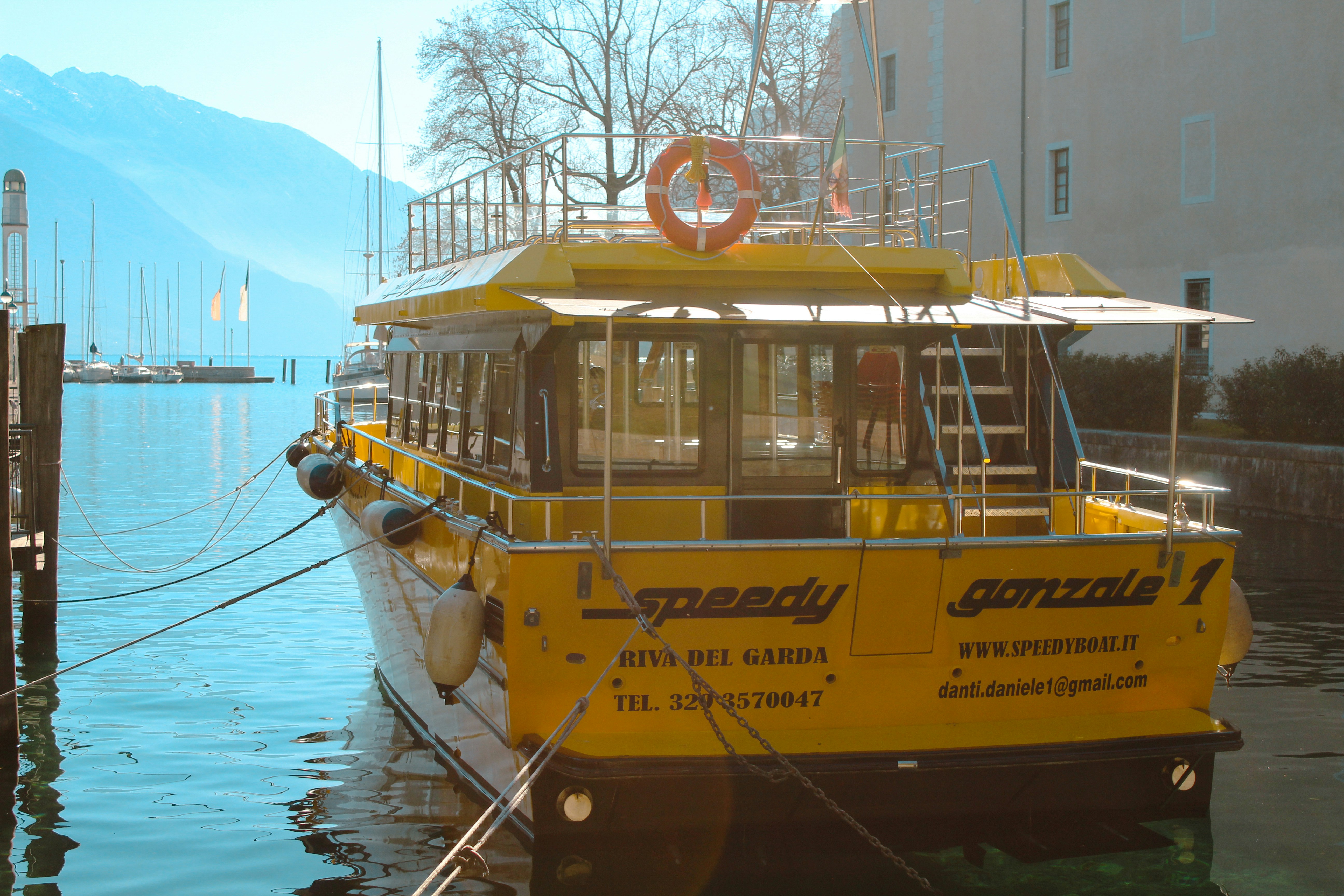 a yellow boat is docked at a dock