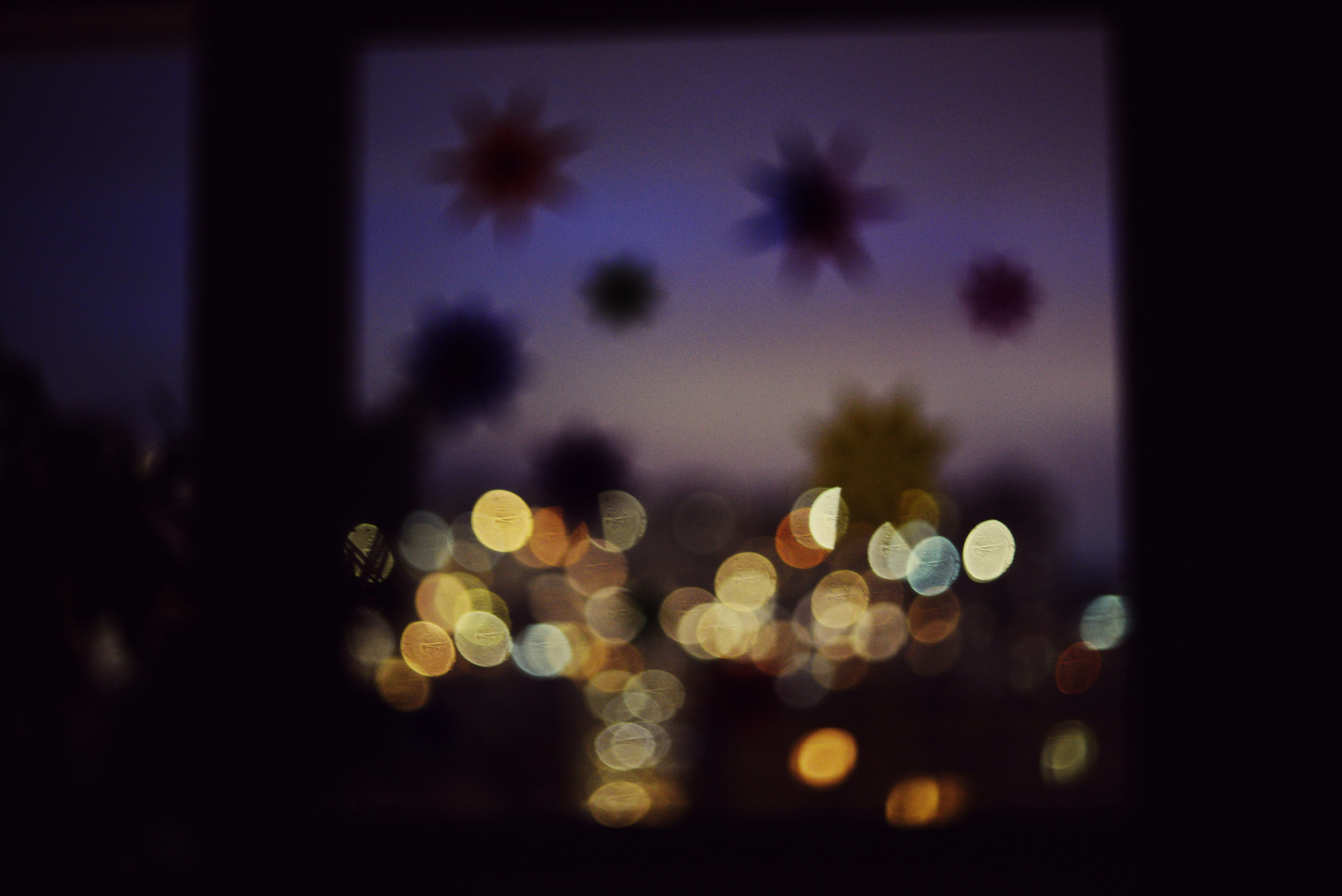 Windowed Night: Starbursts and City Lights Through Blur