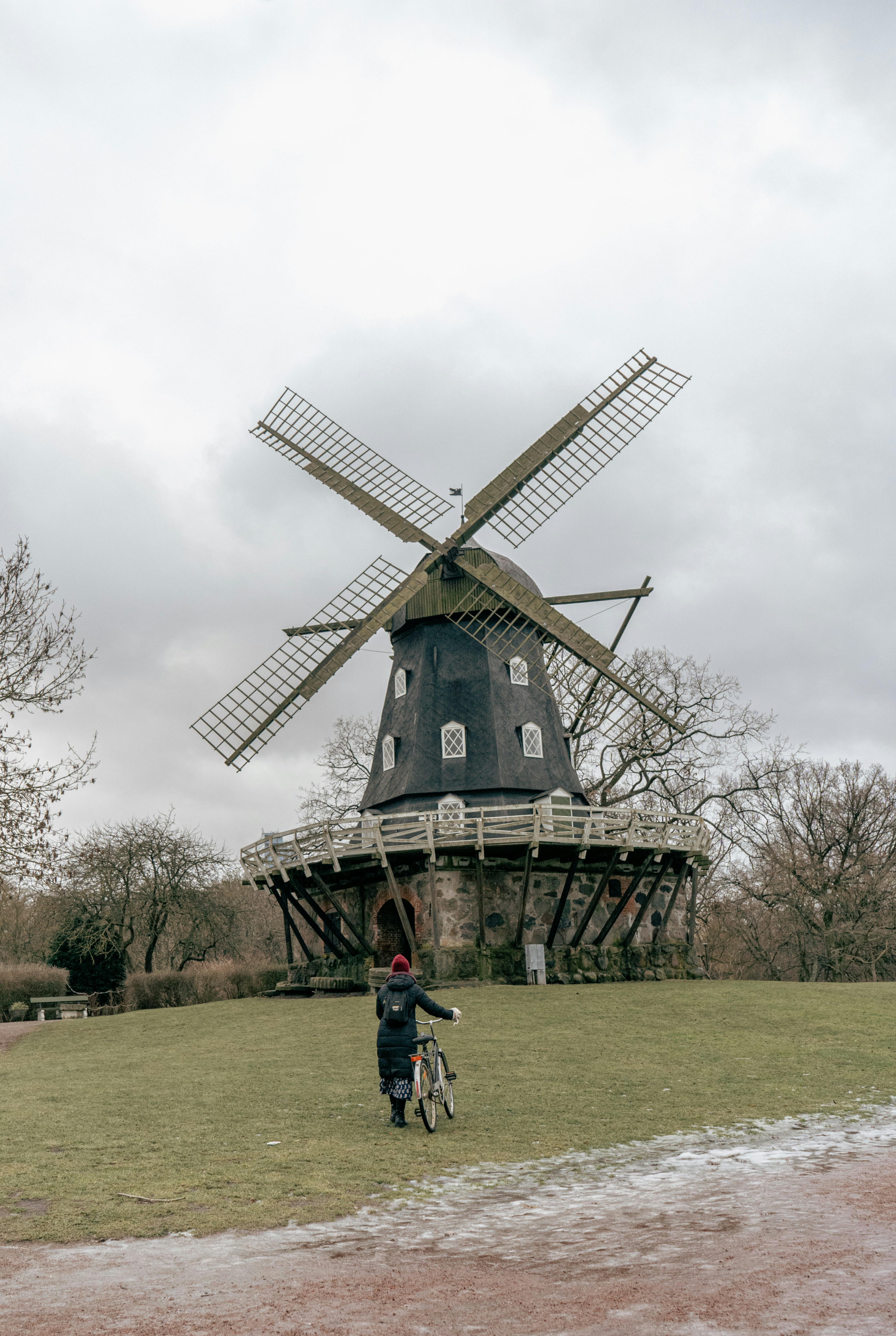 Weathered Windmill at Park's Edge: A Quiet Moment with a Bicycle