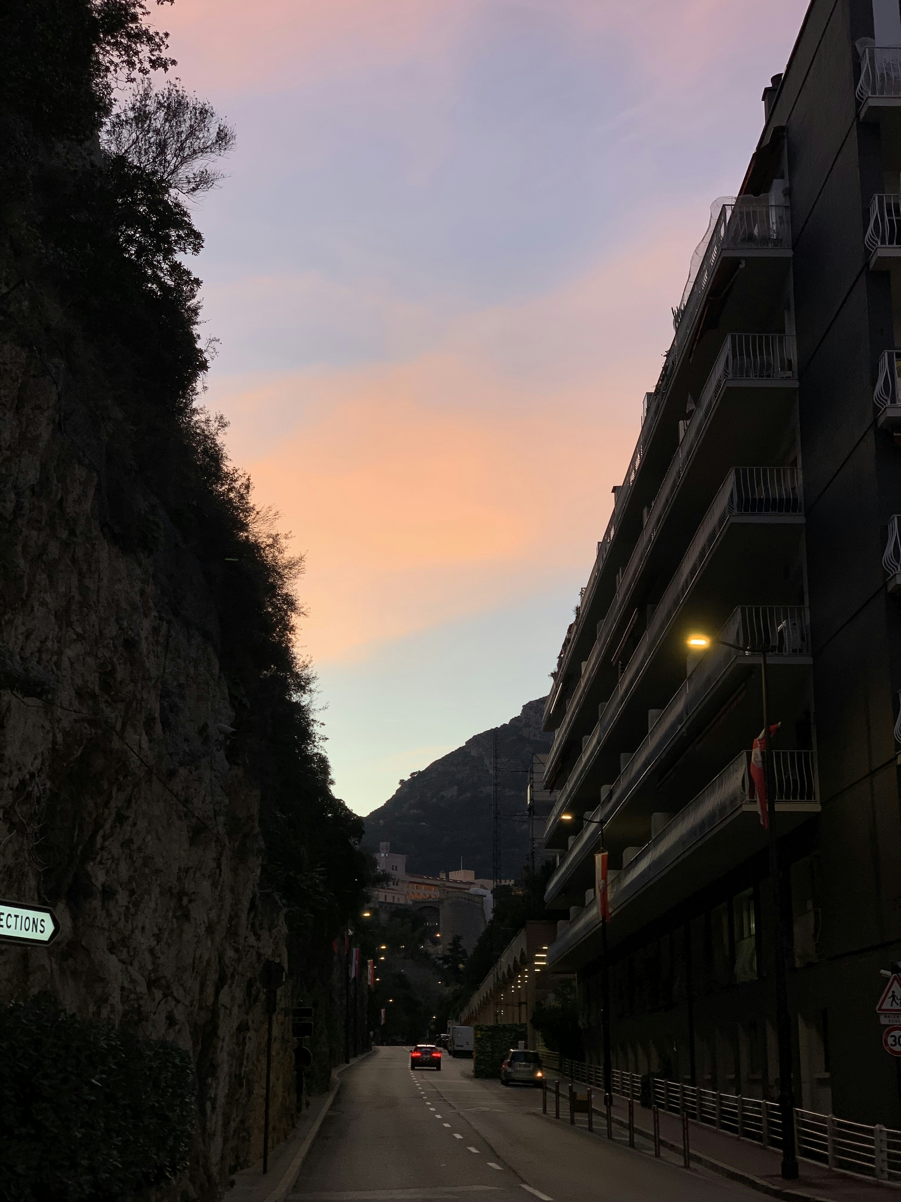 Pastel Dusk Between Cliff and High-Rise: A Narrow Street at Sundown
