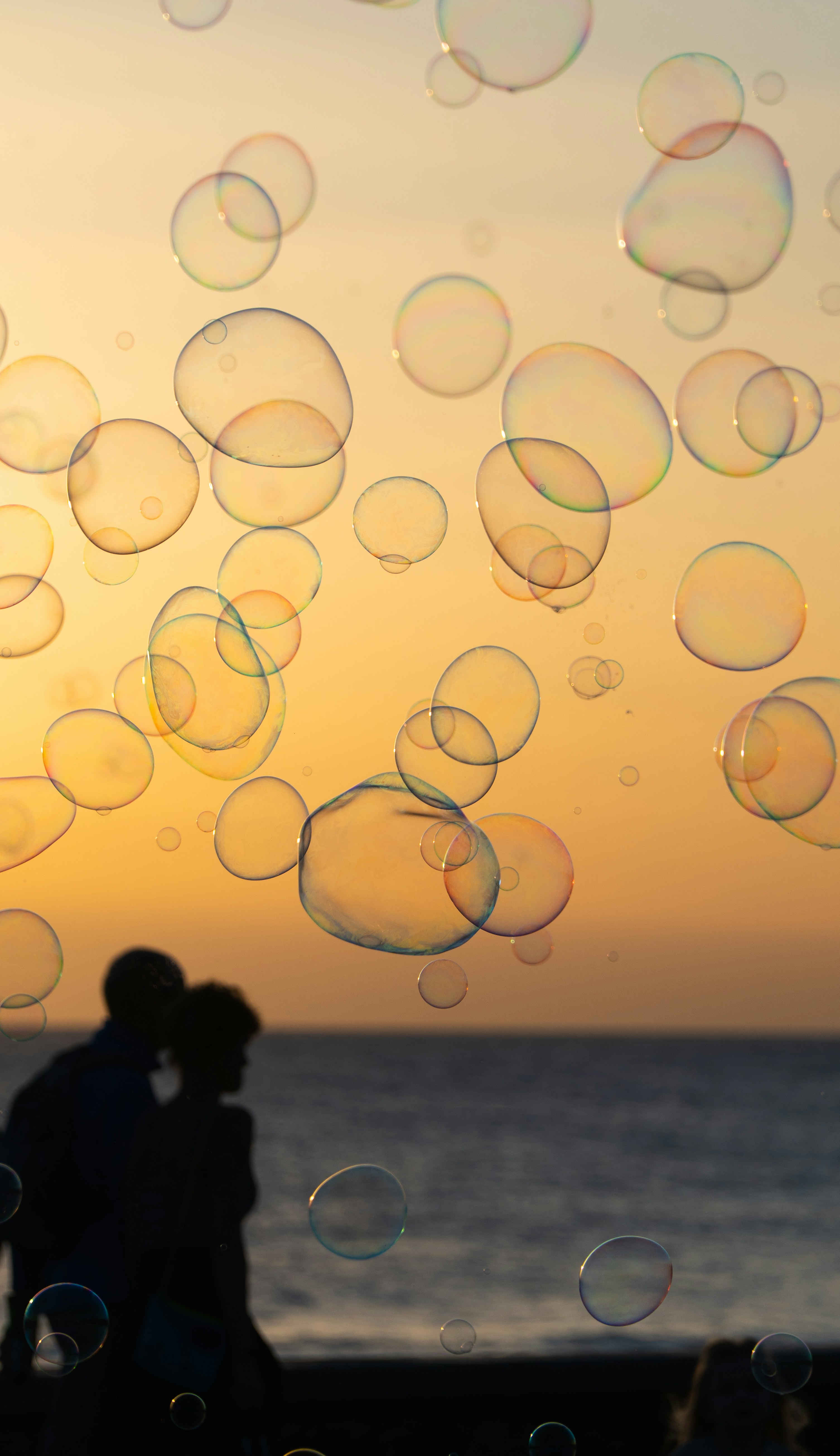 Orbs at Dusk: Bubbles Painting Light Across a Quiet Sea
