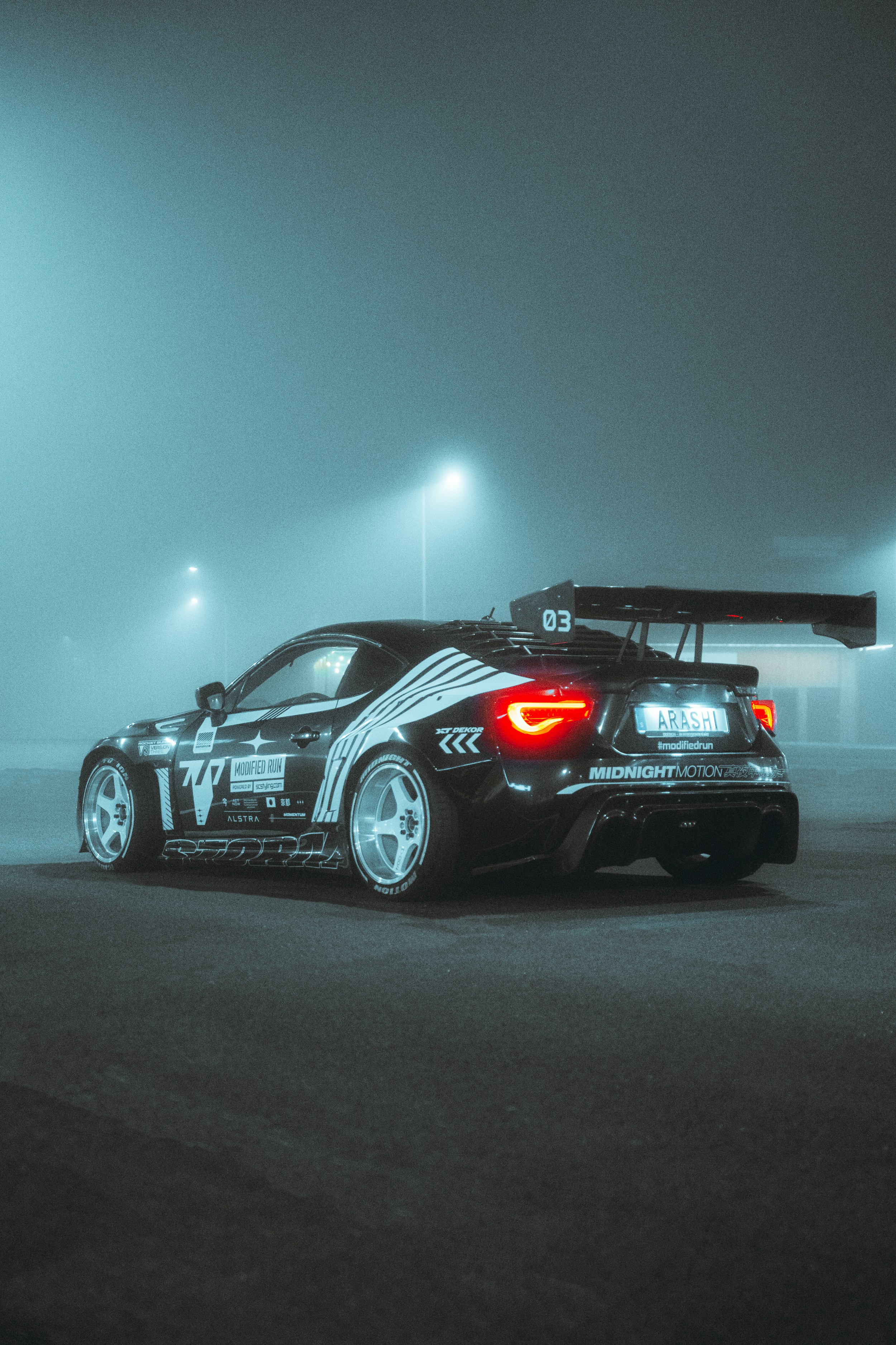 Midnight Drift in Blue Haze: A Racing Coupe in Fog