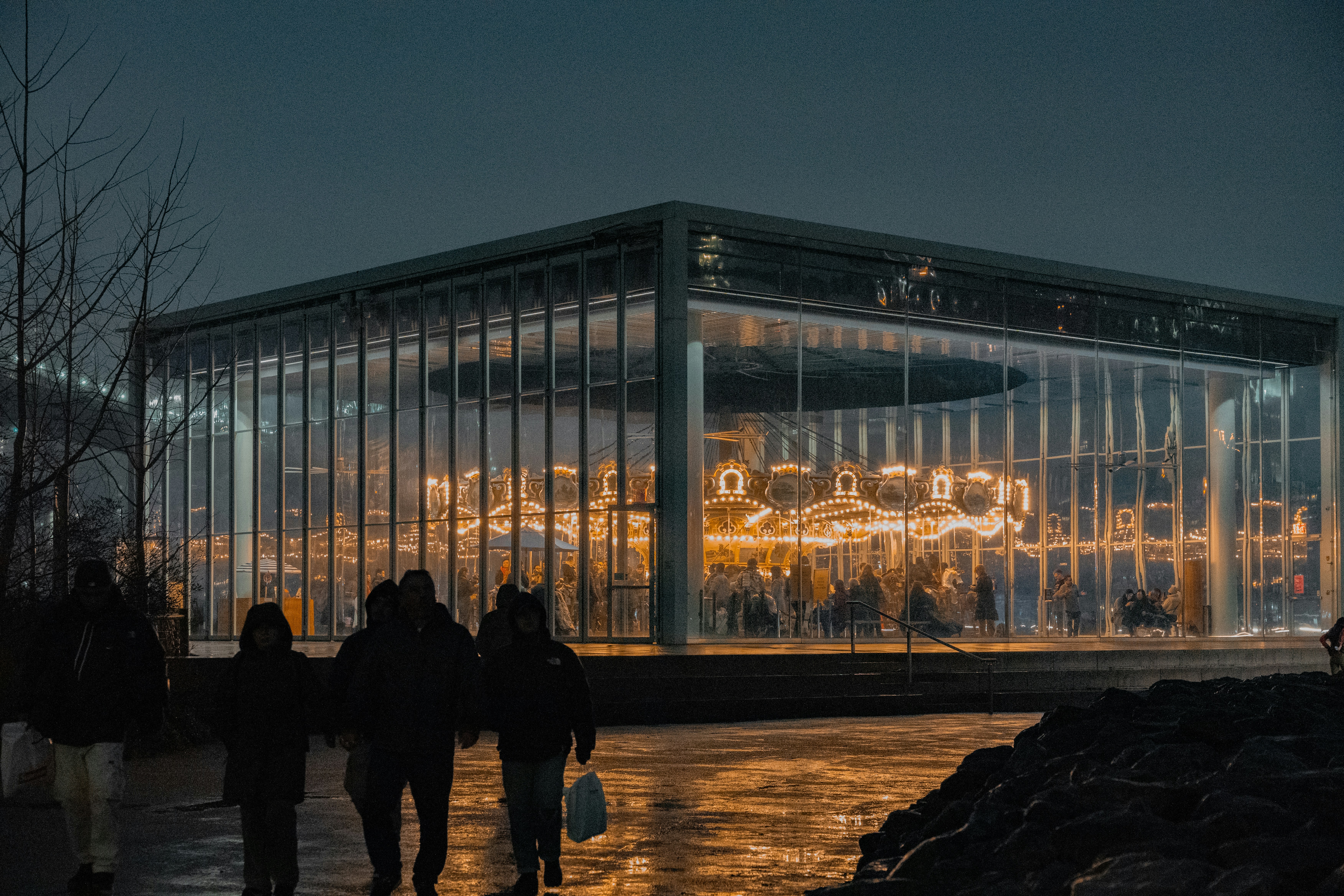 Nocturnal Glasshouse: Warm Lanterns and Silhouettes on a Wet Seafront