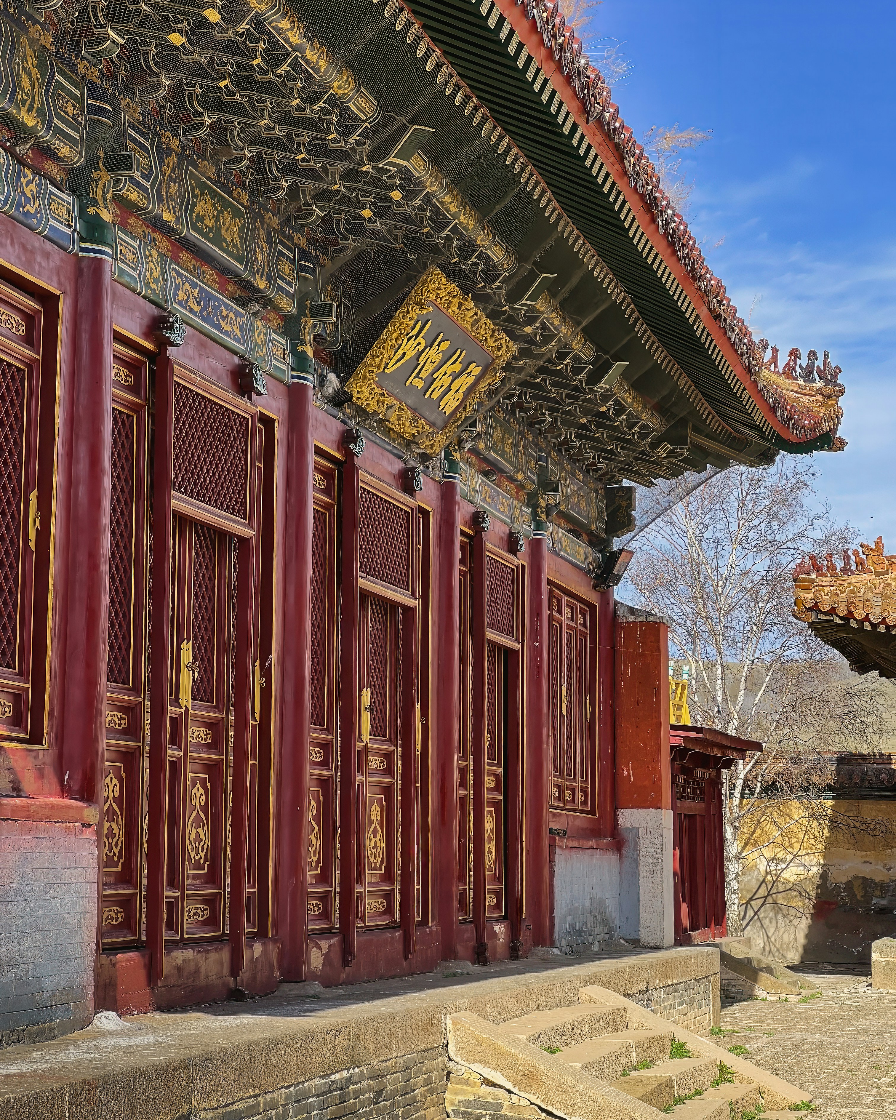 Red-wood Doors and Ornate Eaves of a Chinese Temple Corridor