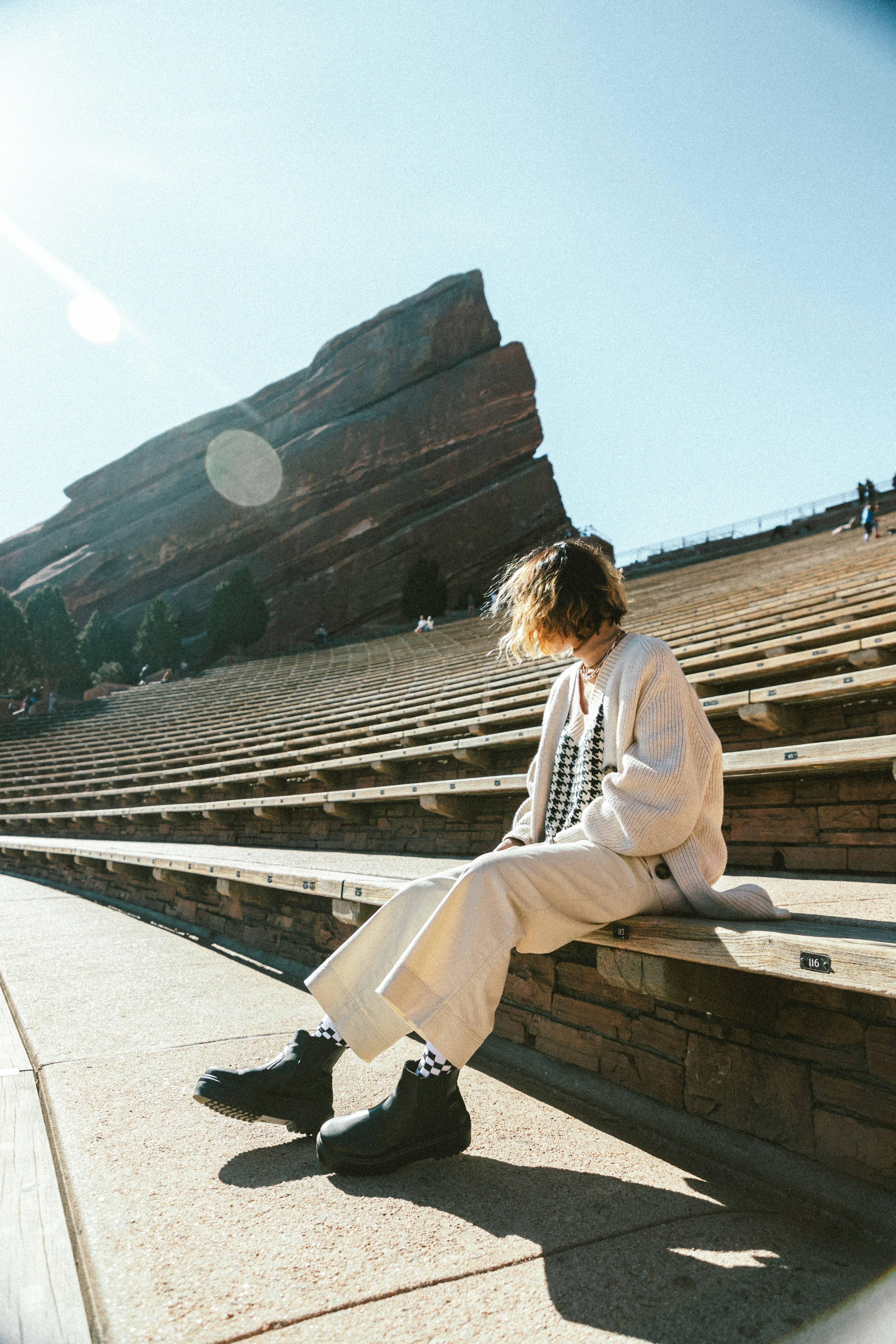 A person sitting on a ledge in a stadium photo – Free Usa Image on Unsplash