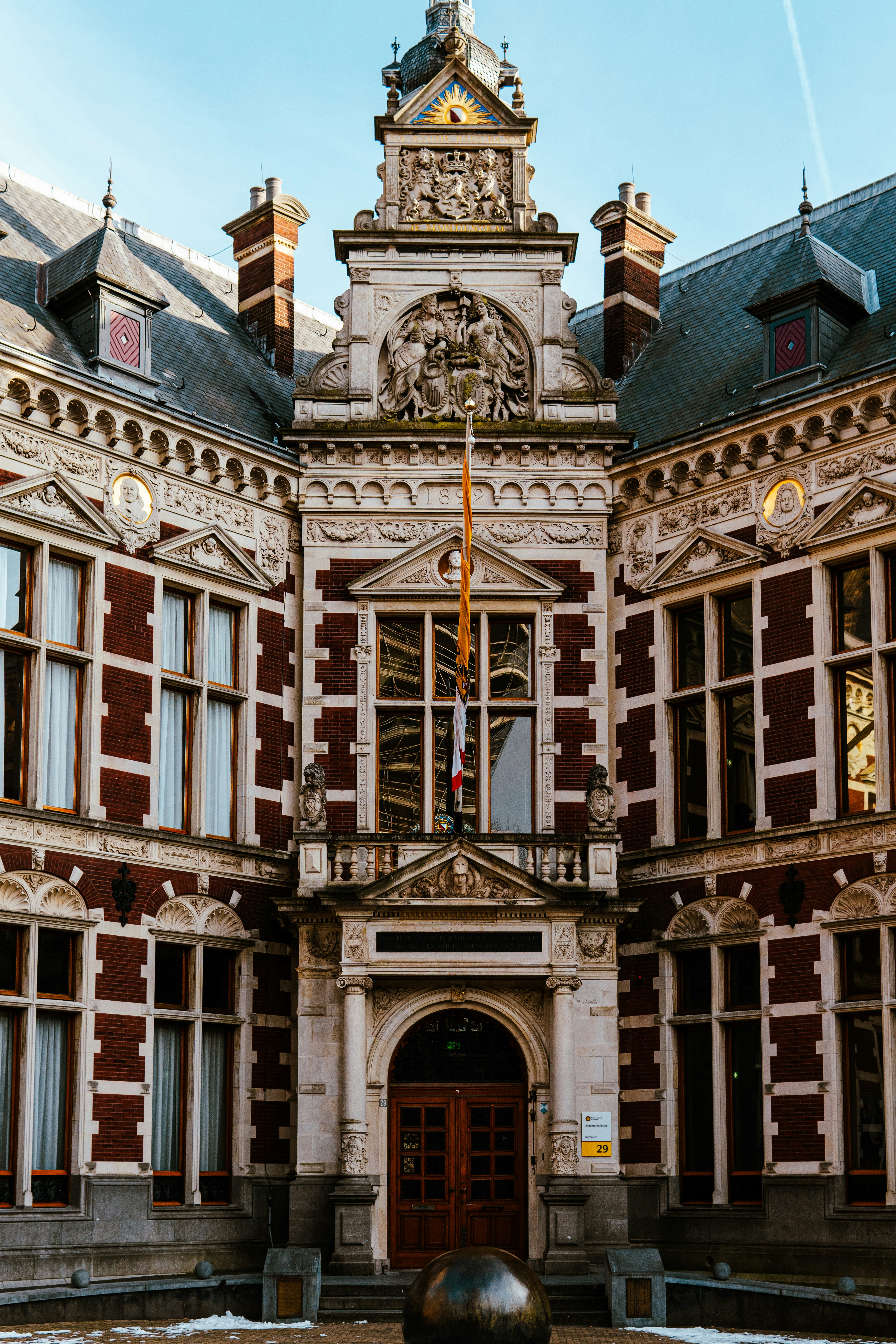 A large building with a clock tower on top of it photo – Free ...