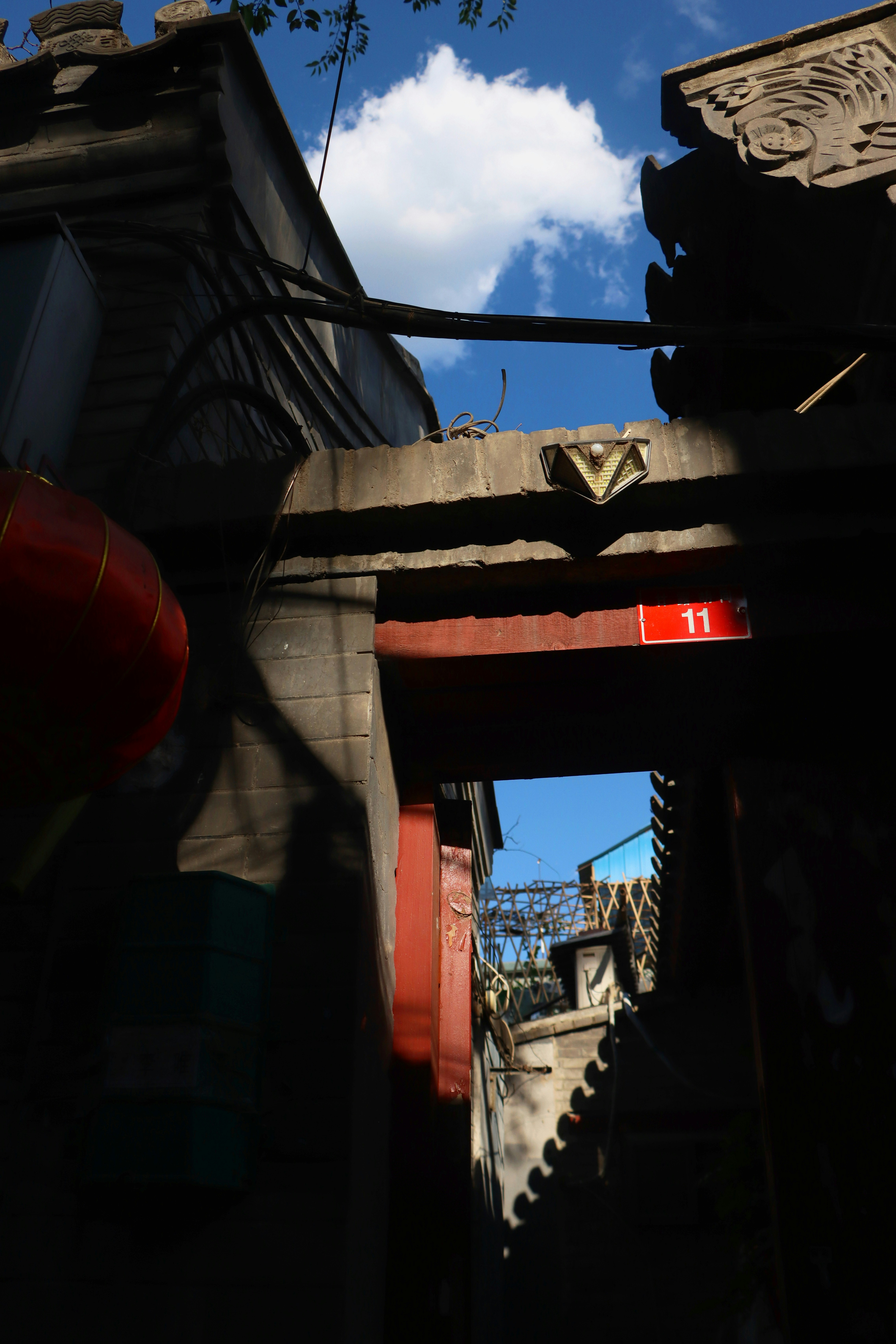 A building with a red sign hanging off of it's side photo – Free City ...