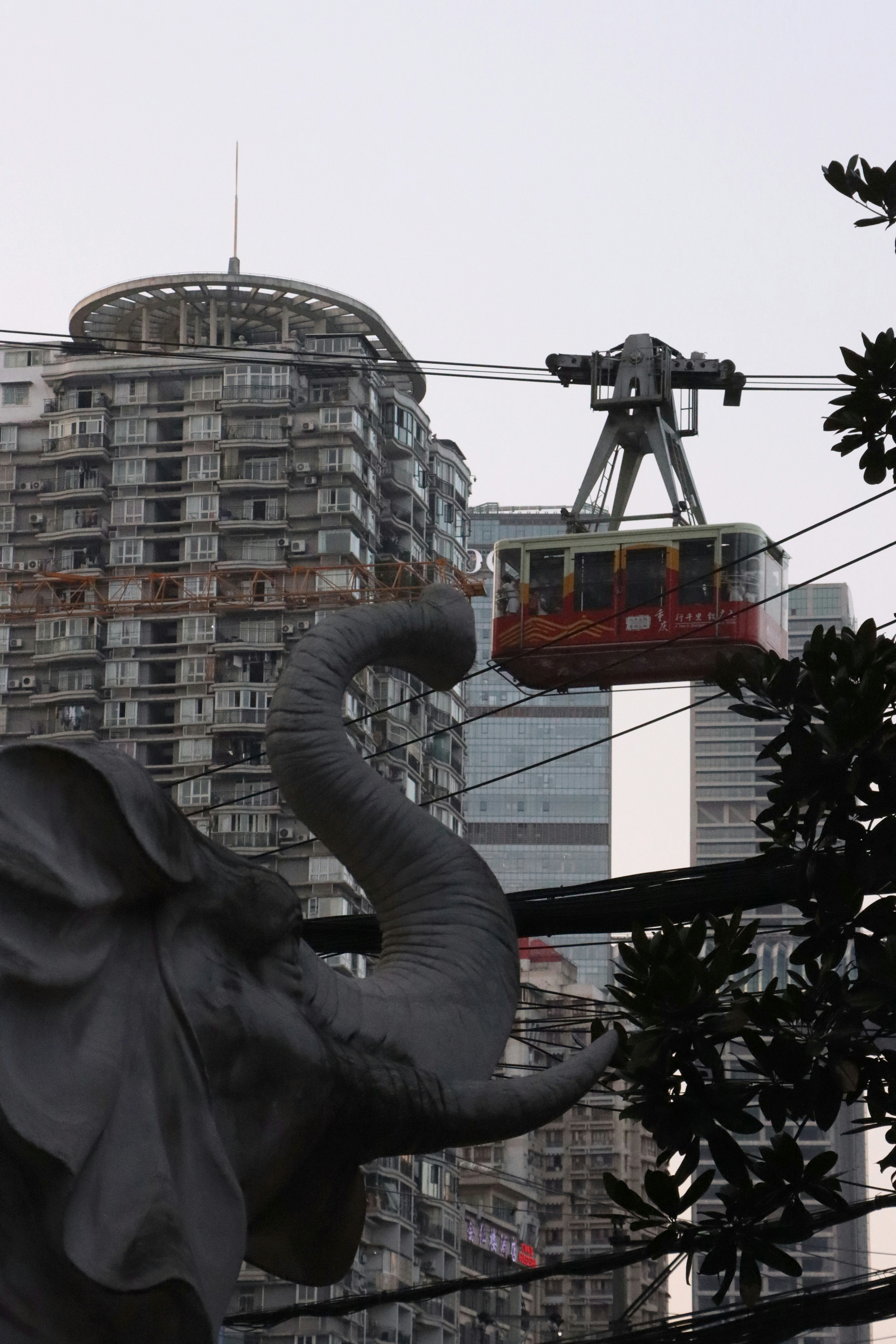 A statue of an elephant with a cable car in the background photo – Free ...