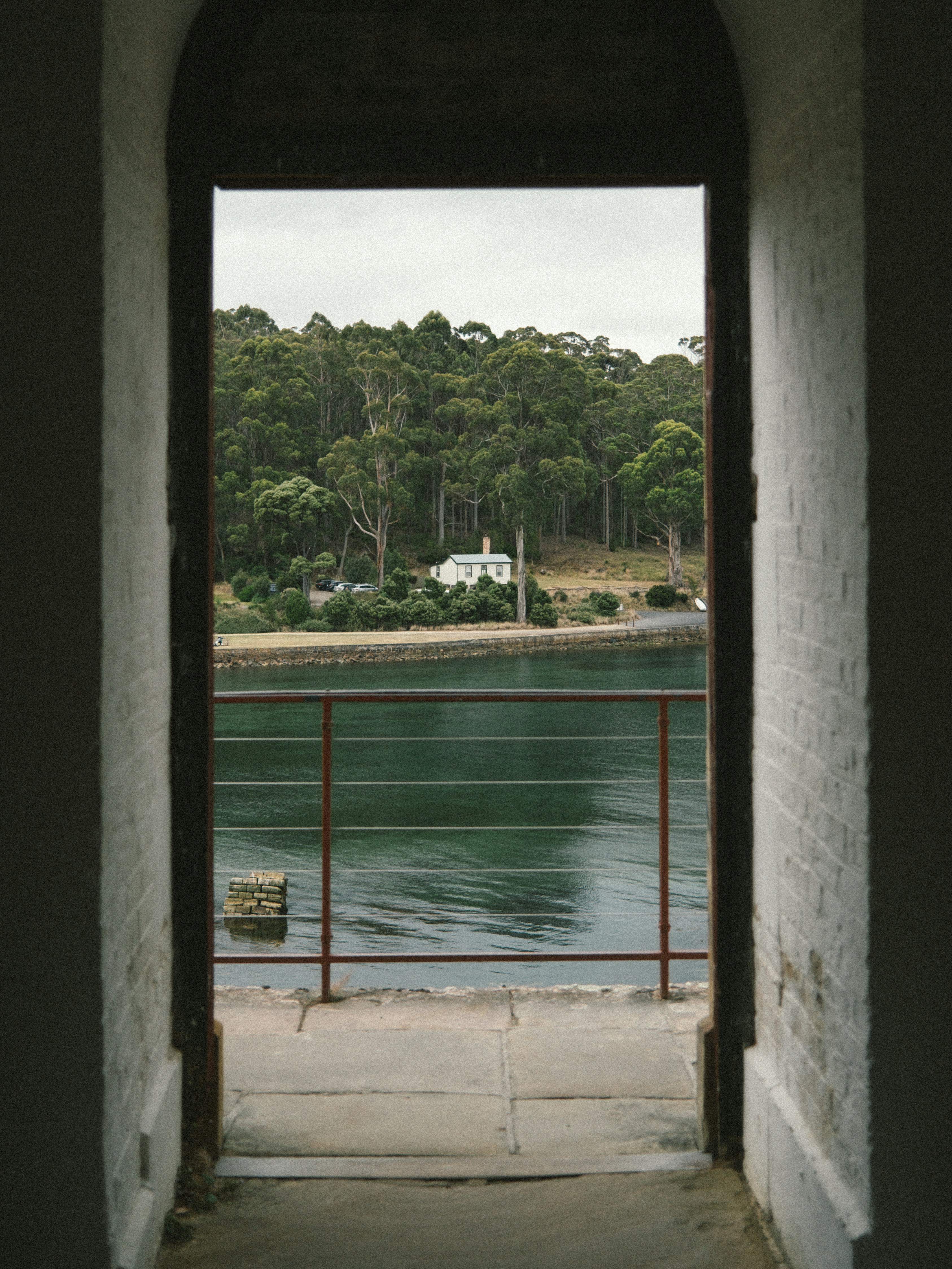 an open doorway leading to a body of water