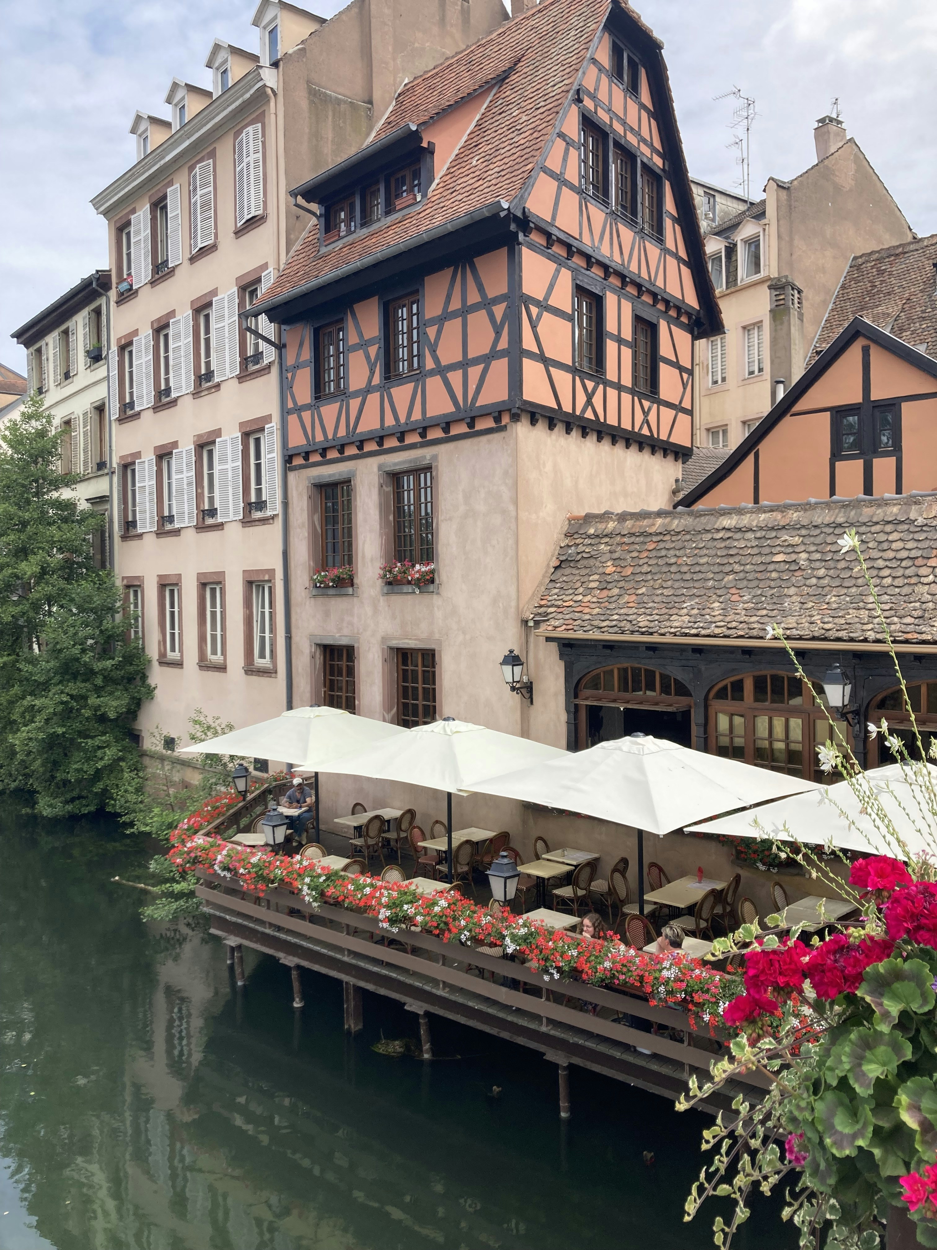 Timber-Framed Charm by the Canal with a Blooming Café Terrace