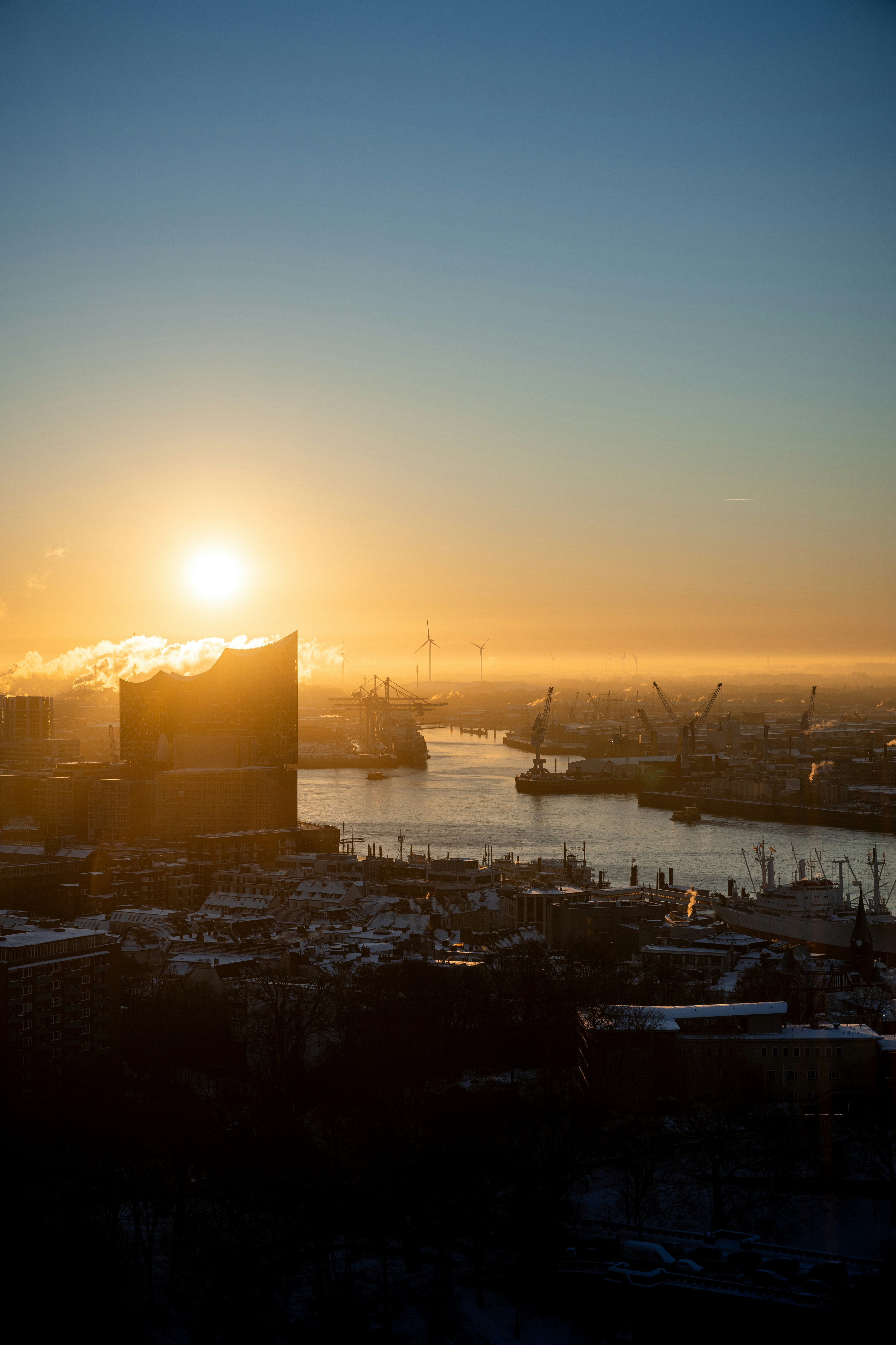 Dawn Over the Docks: Sunlit Silhouettes and a Wind-Turbine Horizon