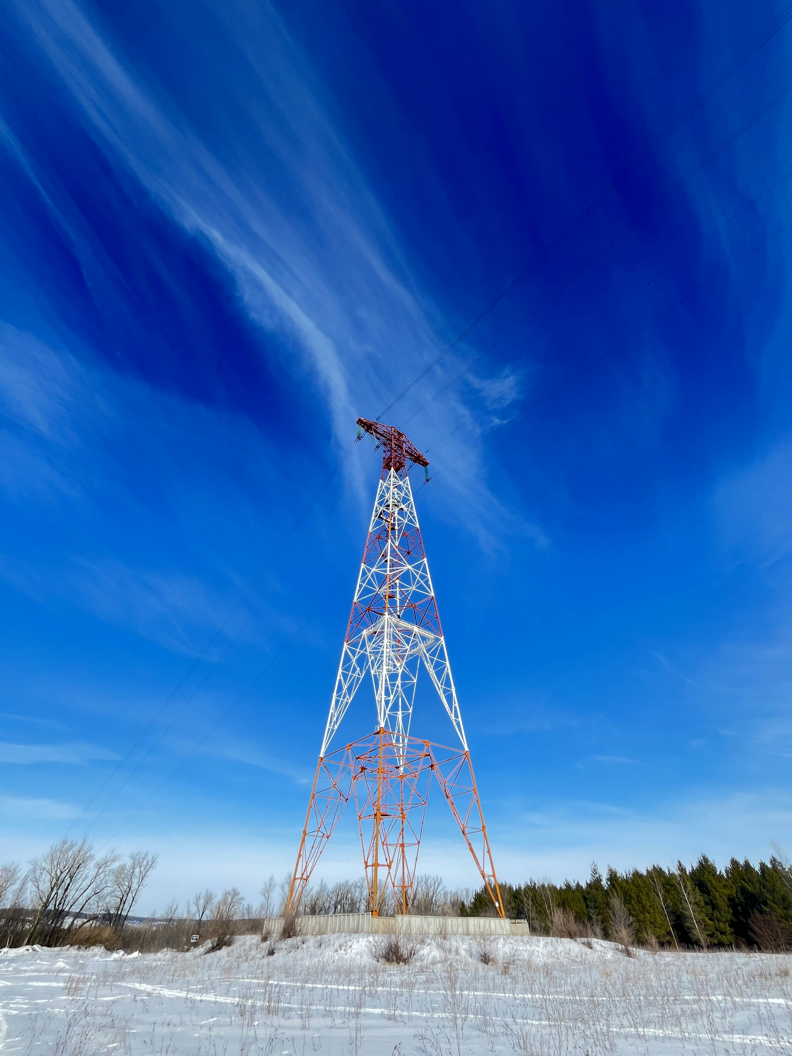Cobalt Sky, White Lattice: A Lone Transmission Tower in Winter