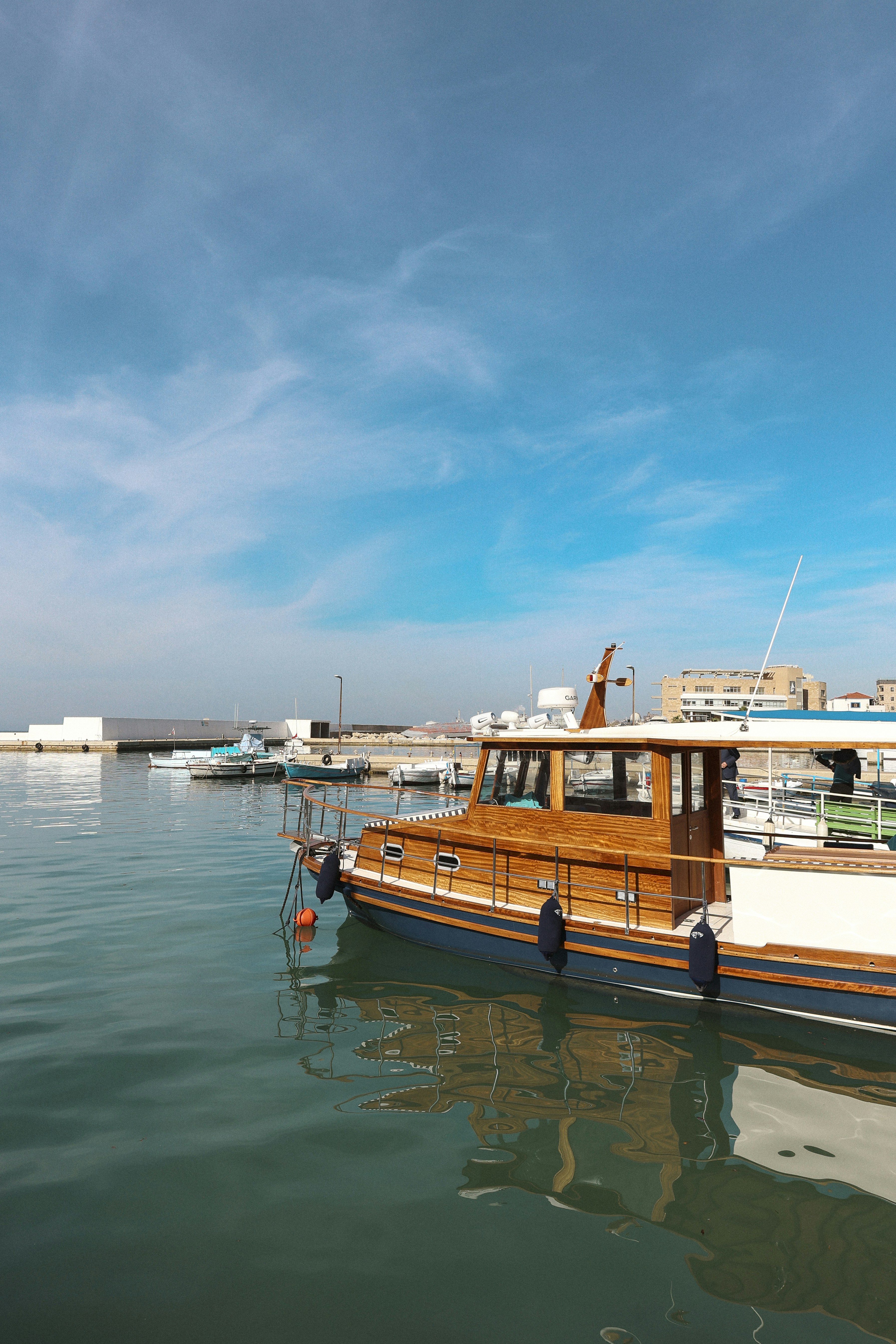 A small boat floating on top of a body of water photo – Free Batroun ...