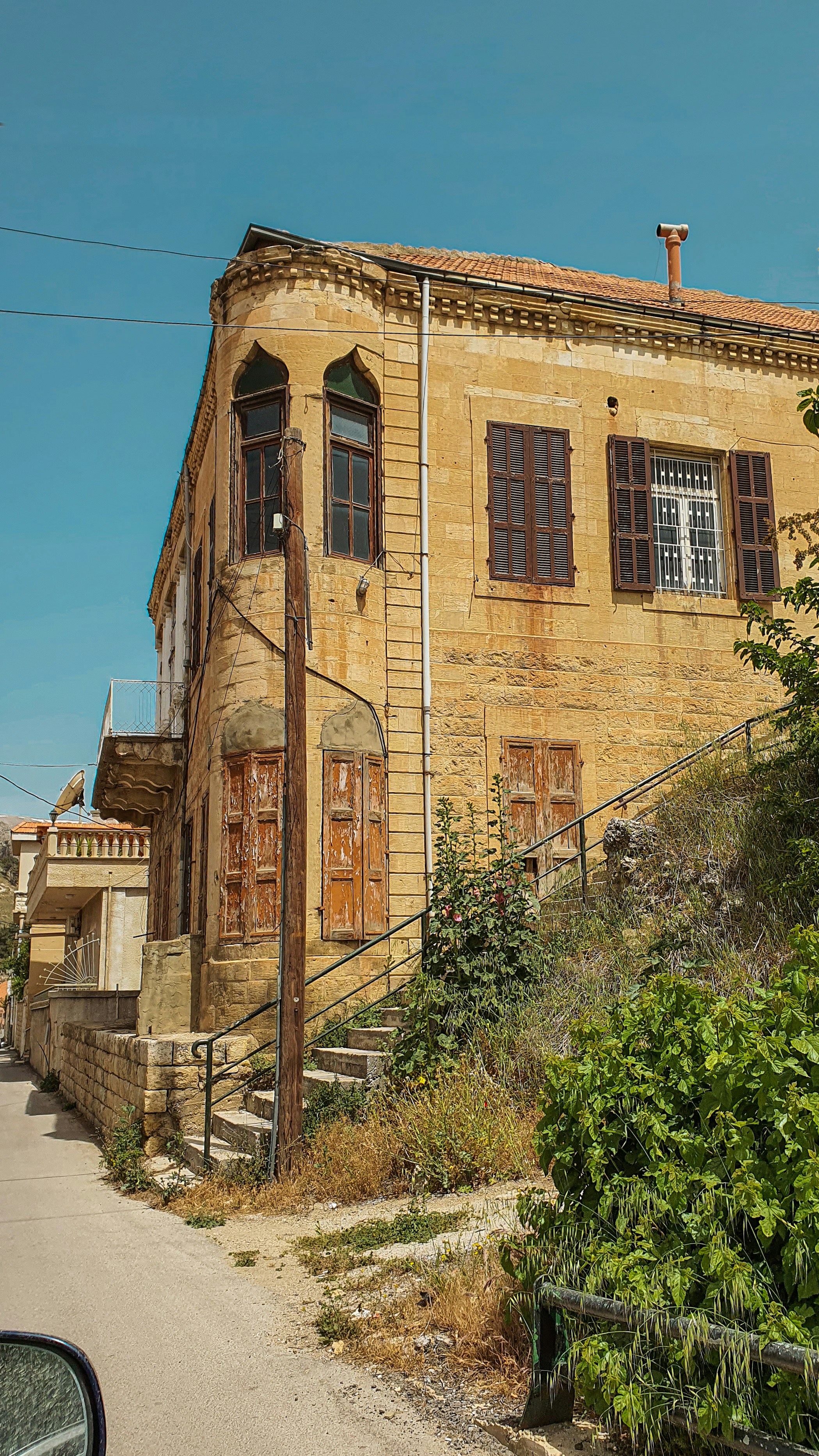 An old building with a lot of windows on the side of it photo – Free ...