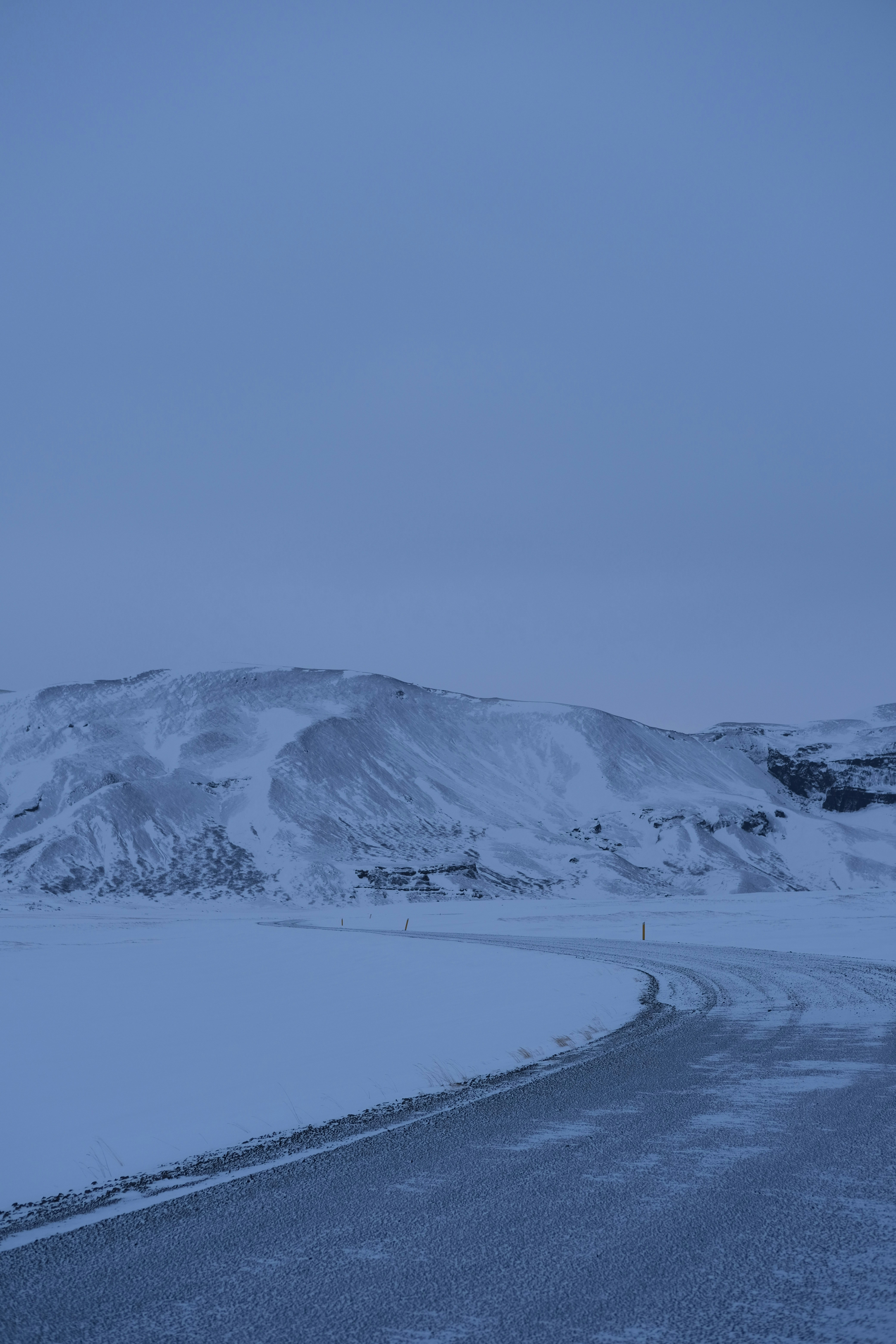 Winding Snow Road Toward the Quiet Ridge at Blue Hour