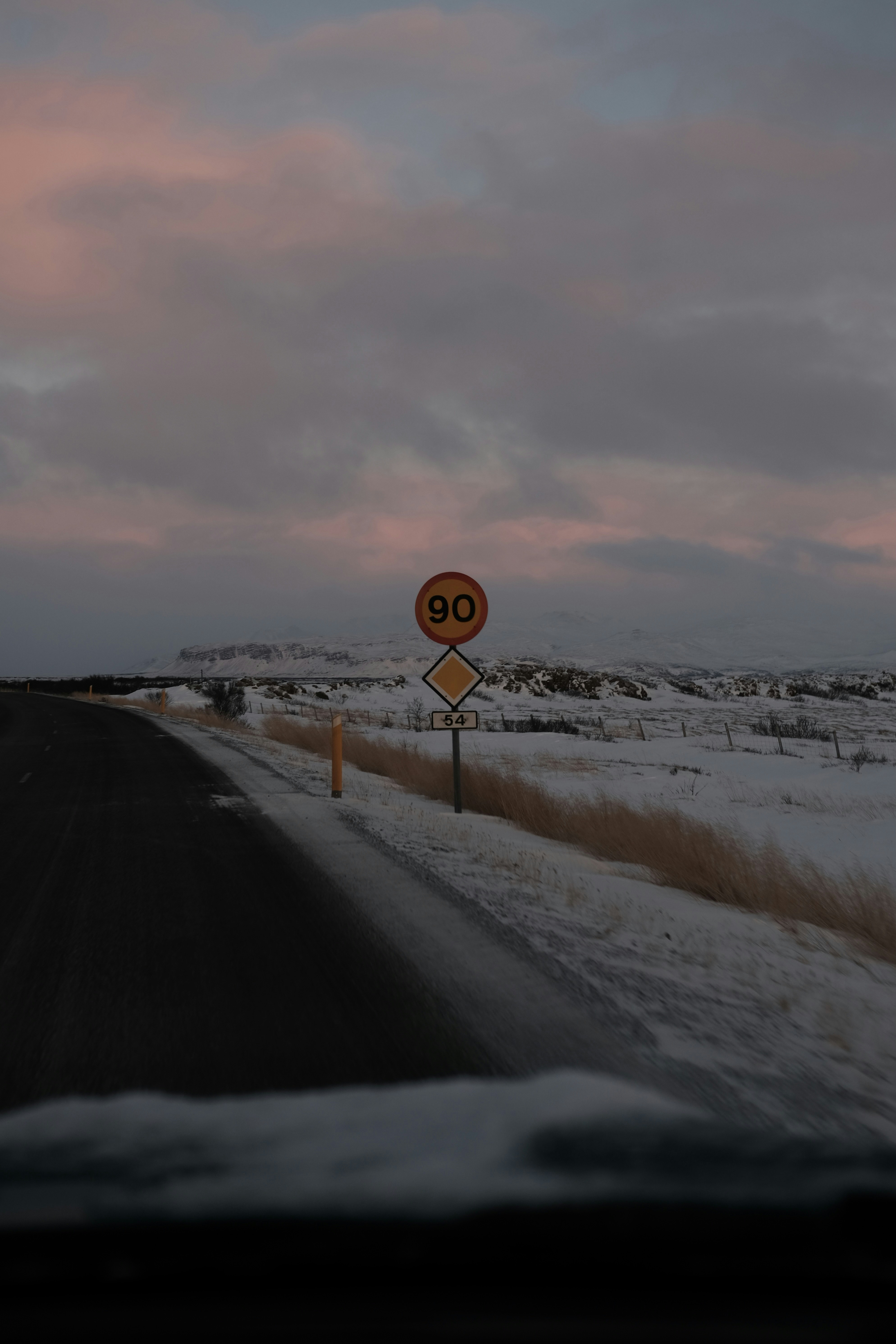 Dusk on the Snow Road: The 90 Sign at the Prairie's Quiet Edge
