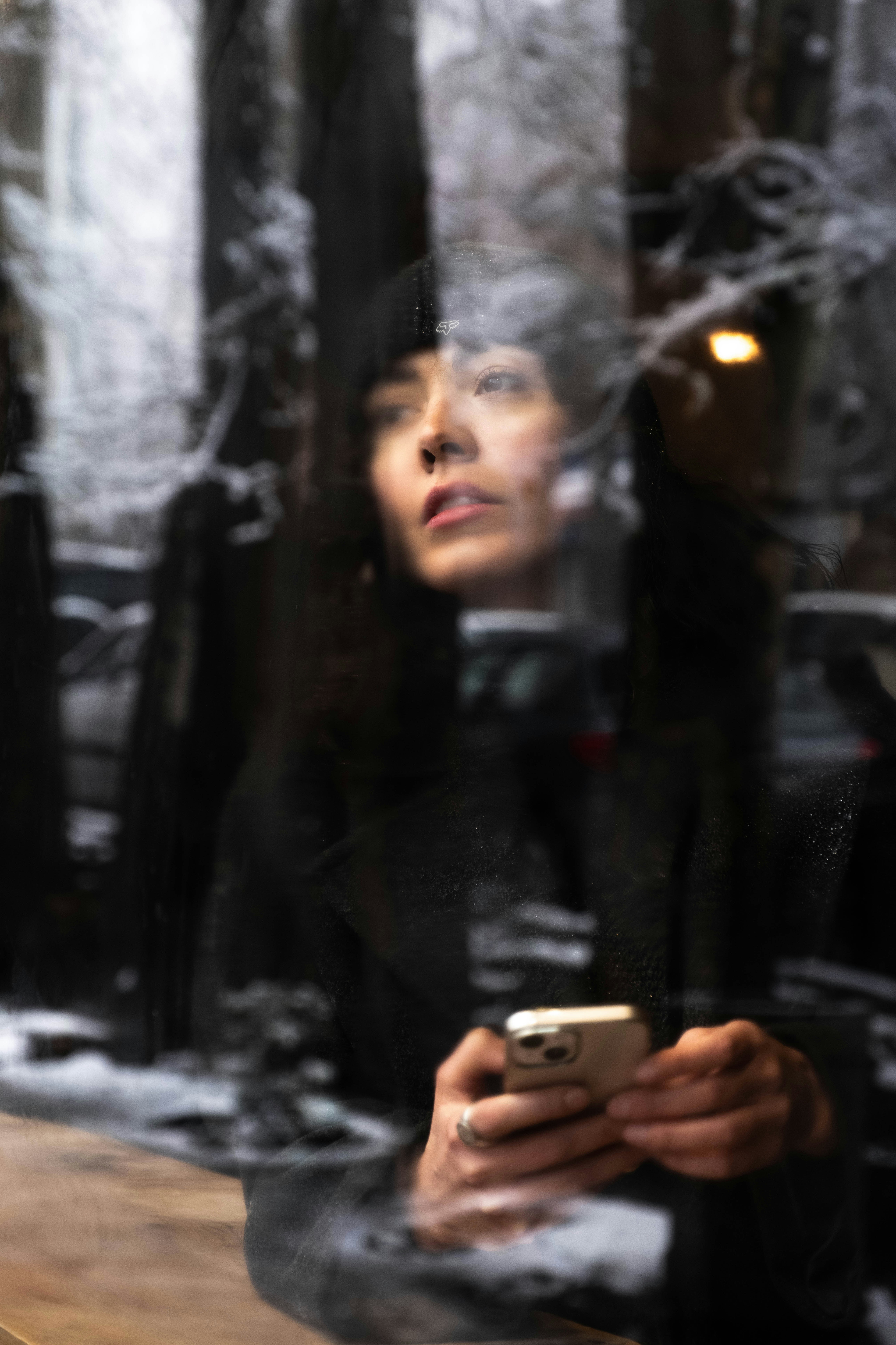 Face in the Window: A Quiet Portrait Through Rain and Reflection