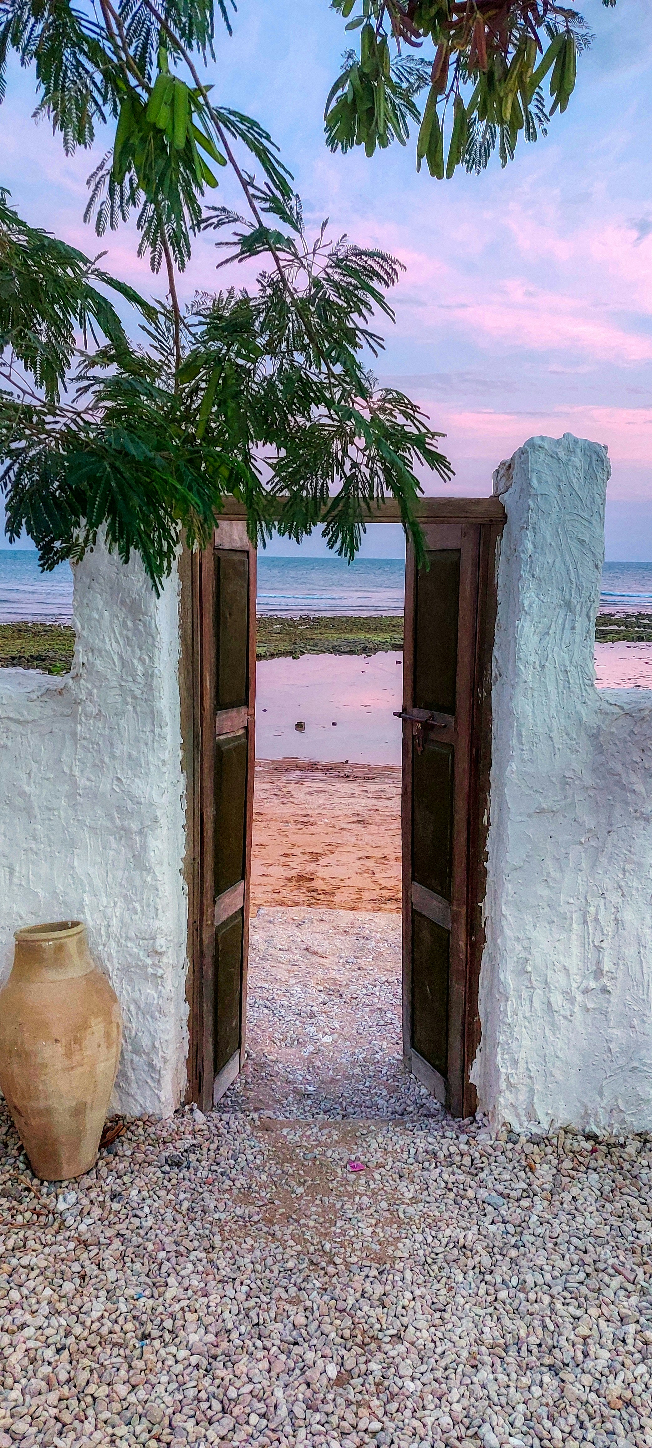 A couple of doors that are open to a beach photo – Free Beach Image on ...