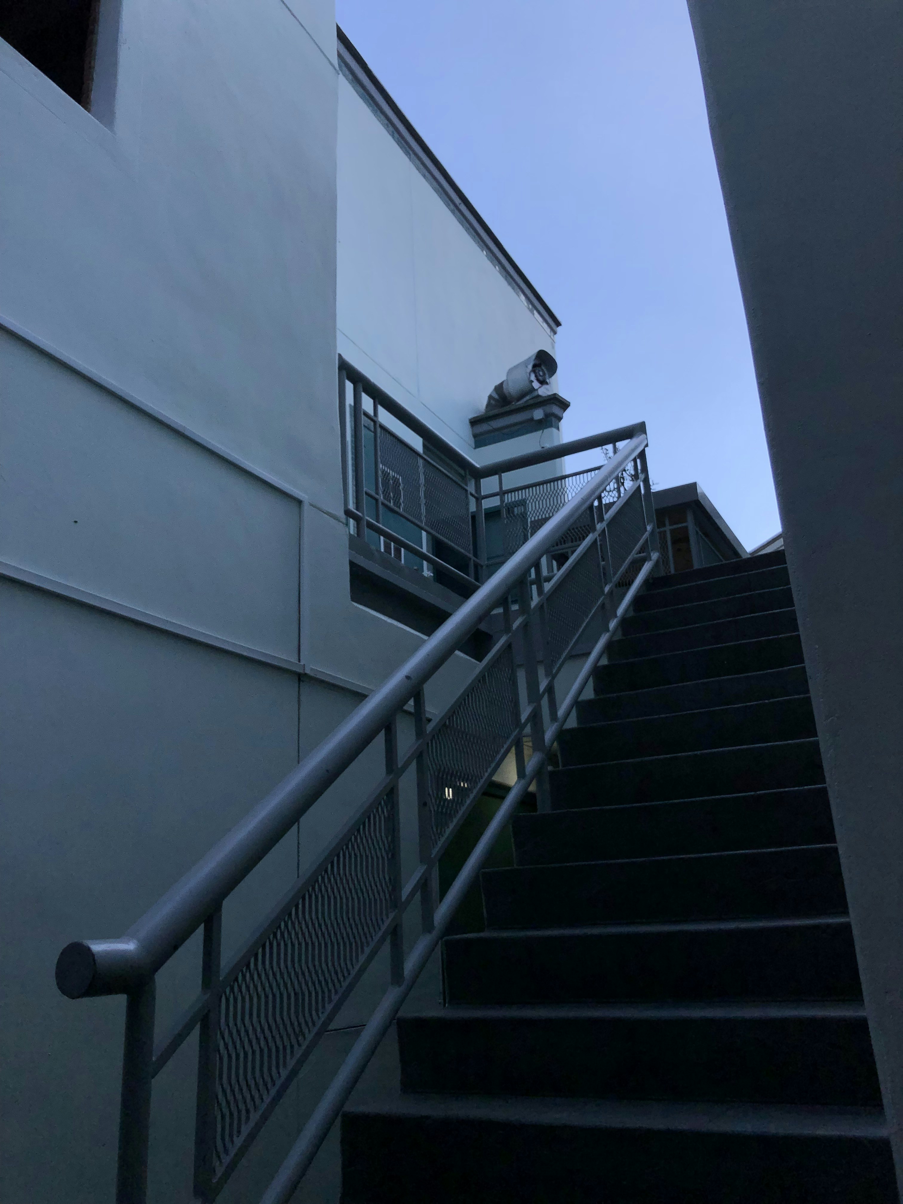 A stair rail leading up to a building photo – Free Building Image on ...