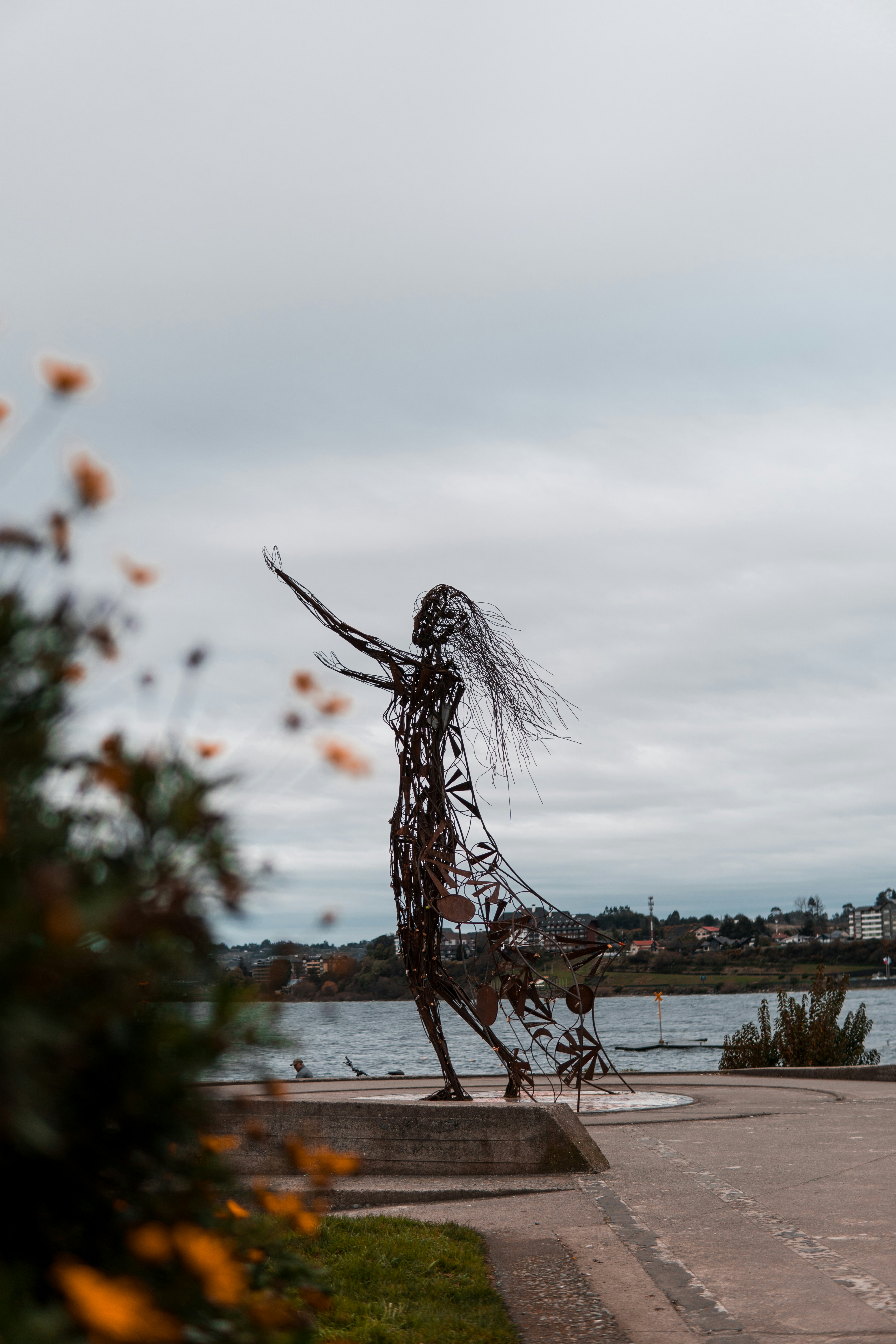 Wrought Figure at Waterside: A Quiet Steel Silhouette Against the Horizon