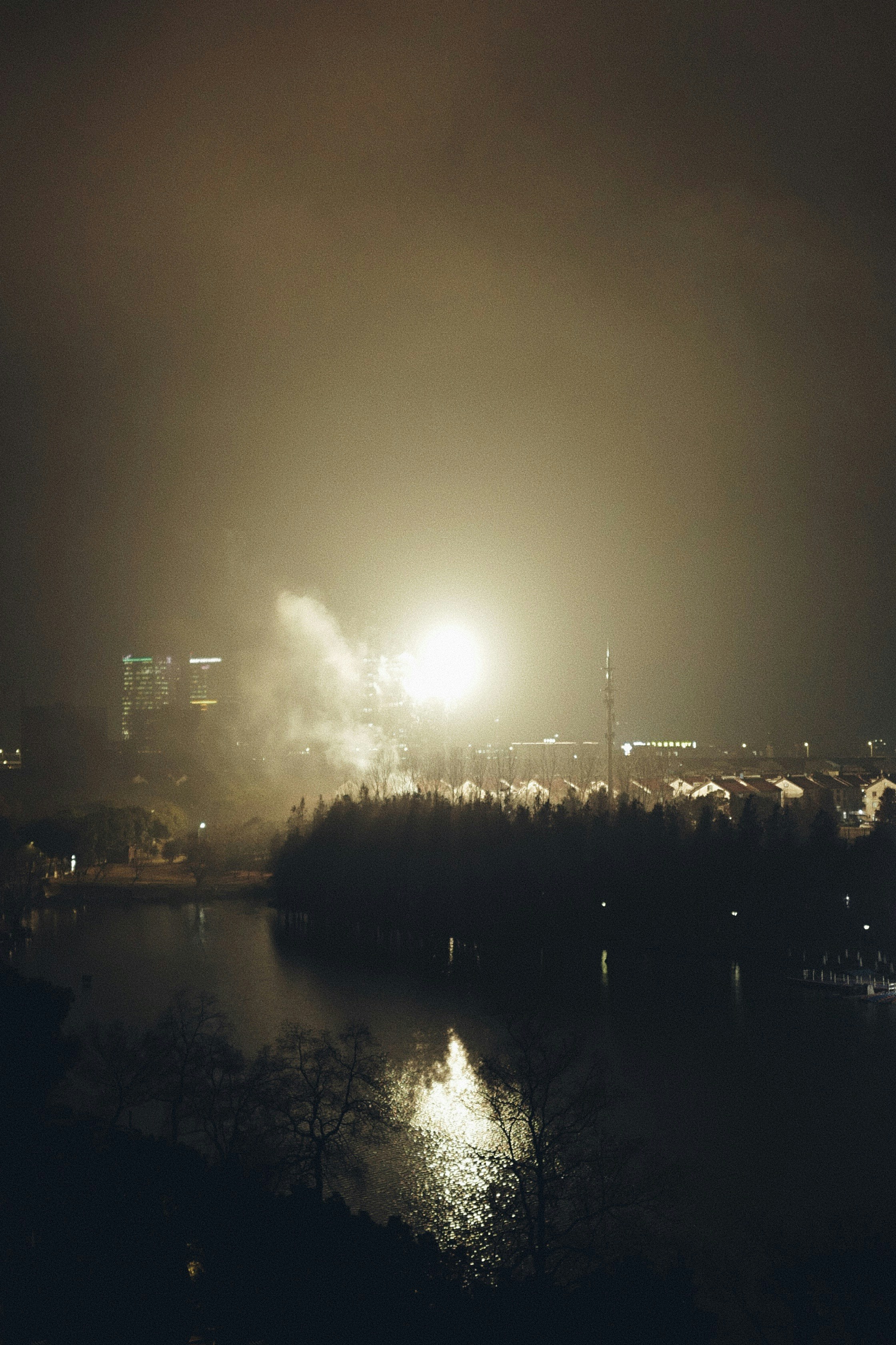 Gilded Burst Over the Riverfront City at Midnight