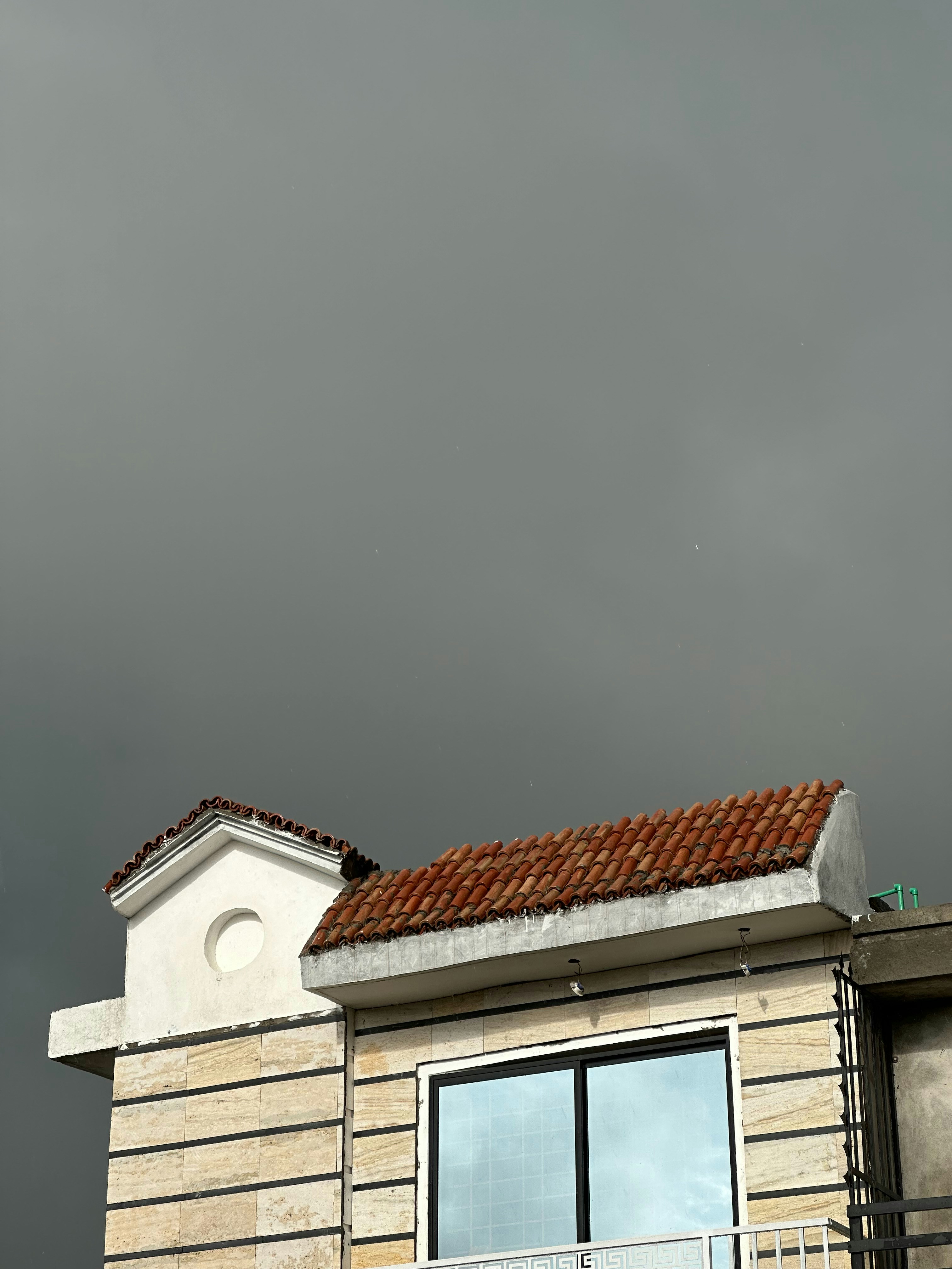 Terracotta Roofline Beneath a Brooding Sky
