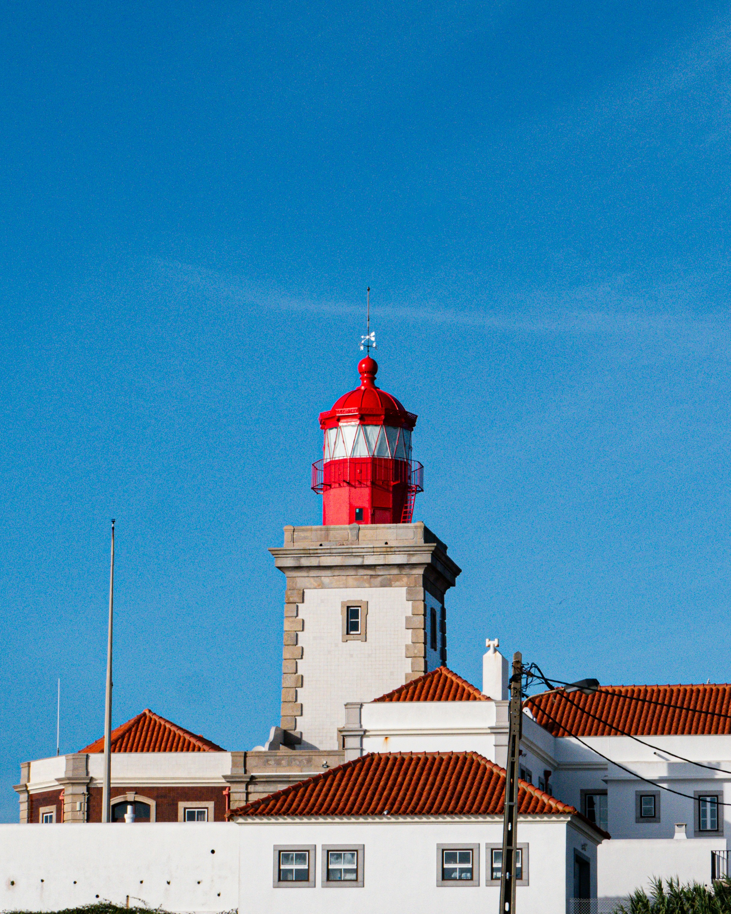a red and white lighthouse on top of a buildingAlvin David