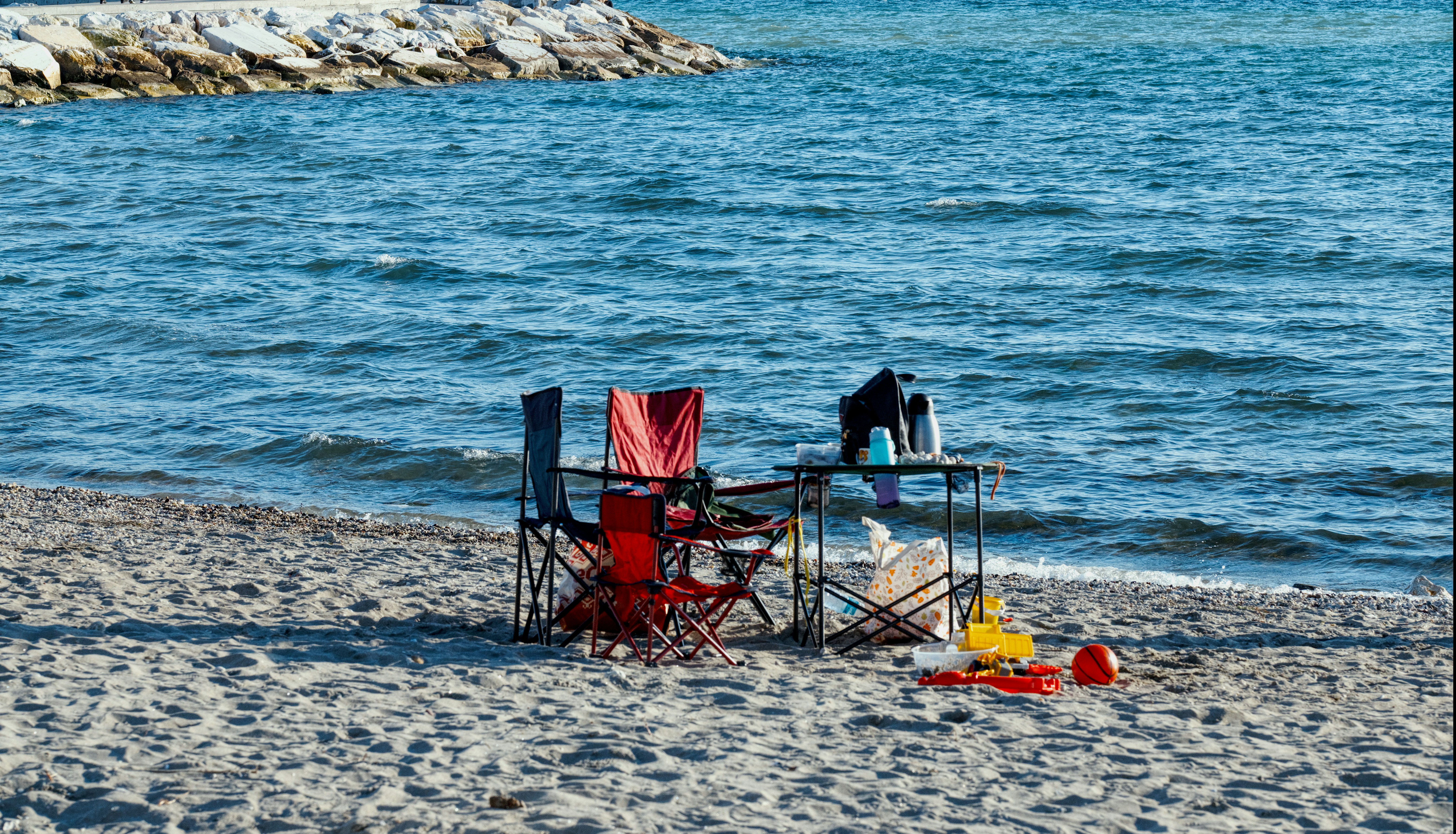 Red Chairs by the Sea: a Quiet Beach Moment