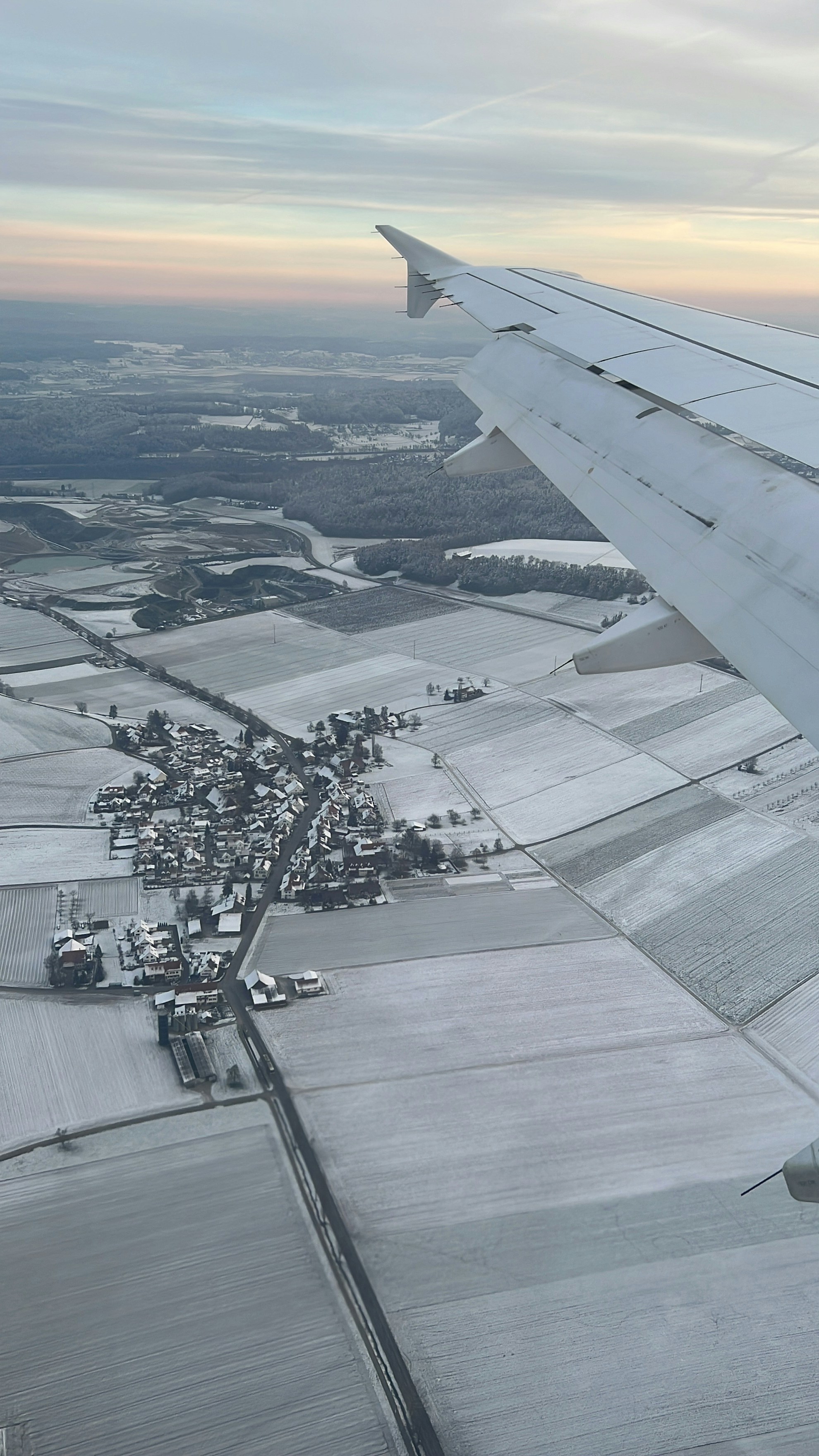 Wing over a Winter Quilt: Snow-Covered Fields from the Window