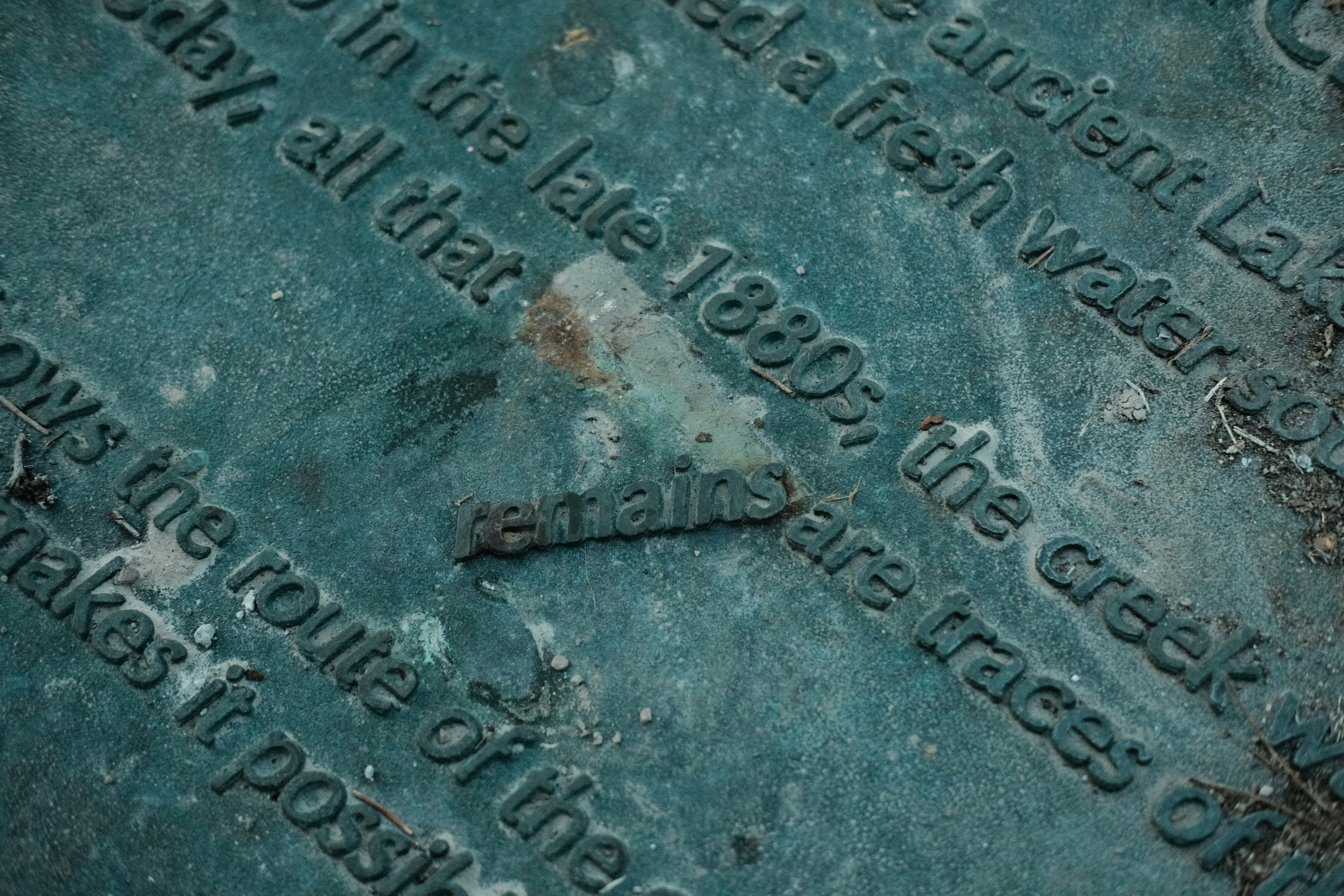 A close up of a metal plate with writing on it photo – Free Sign Image ...