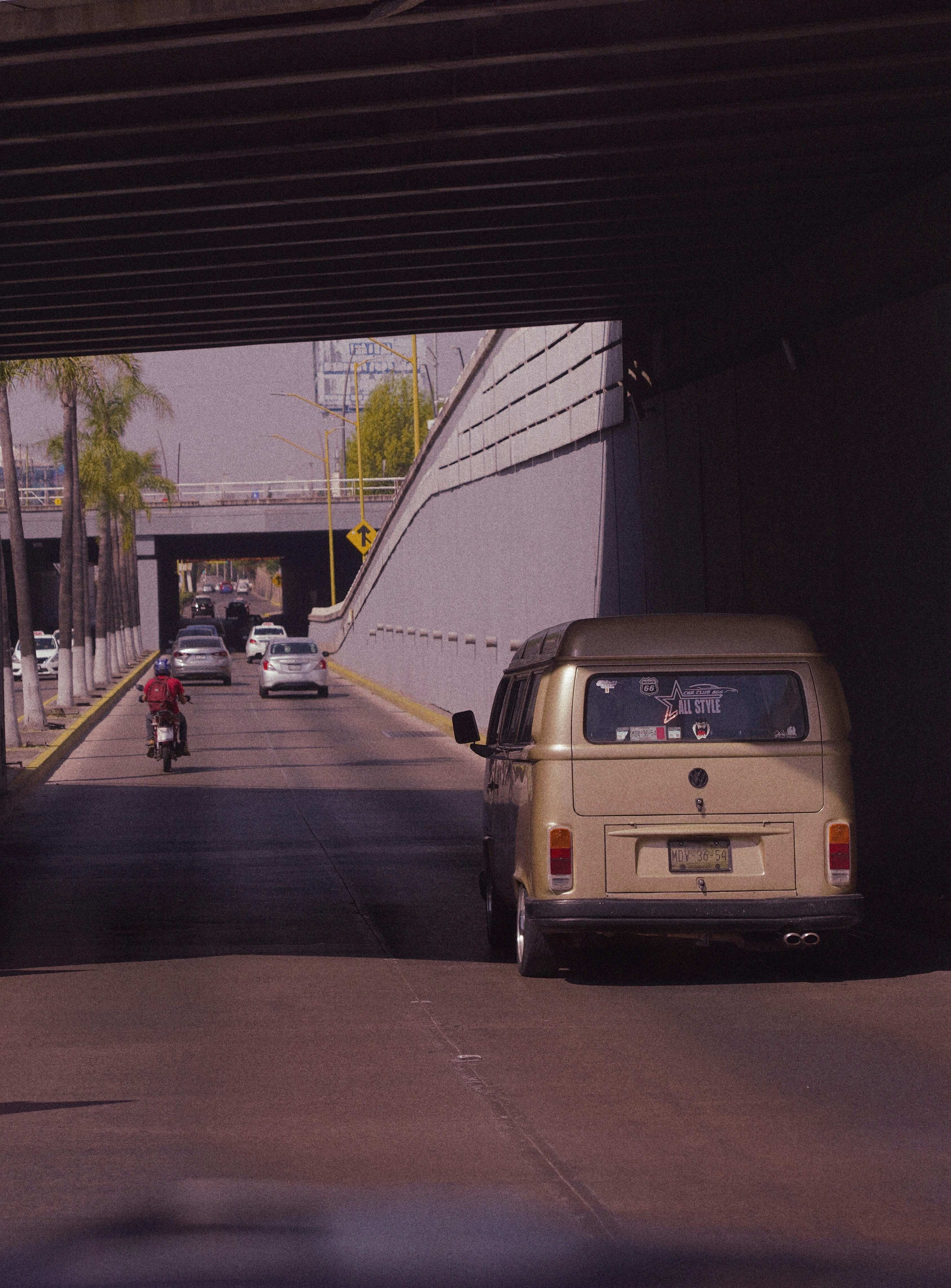 A car driving under a bridge next to a motorcycle photo – Free Old cars ...