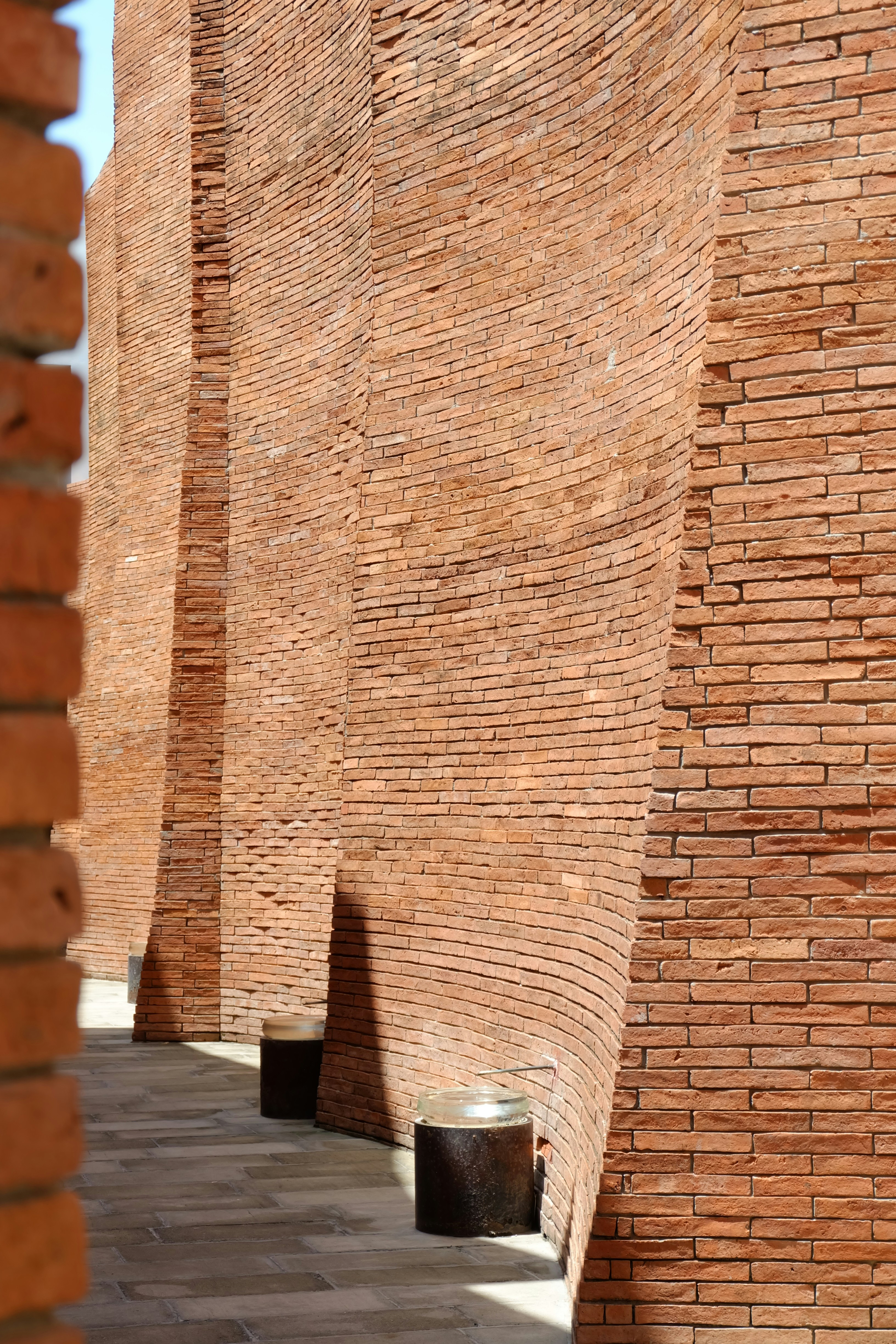 Brick Arc in the Sun: A Quiet Courtyard