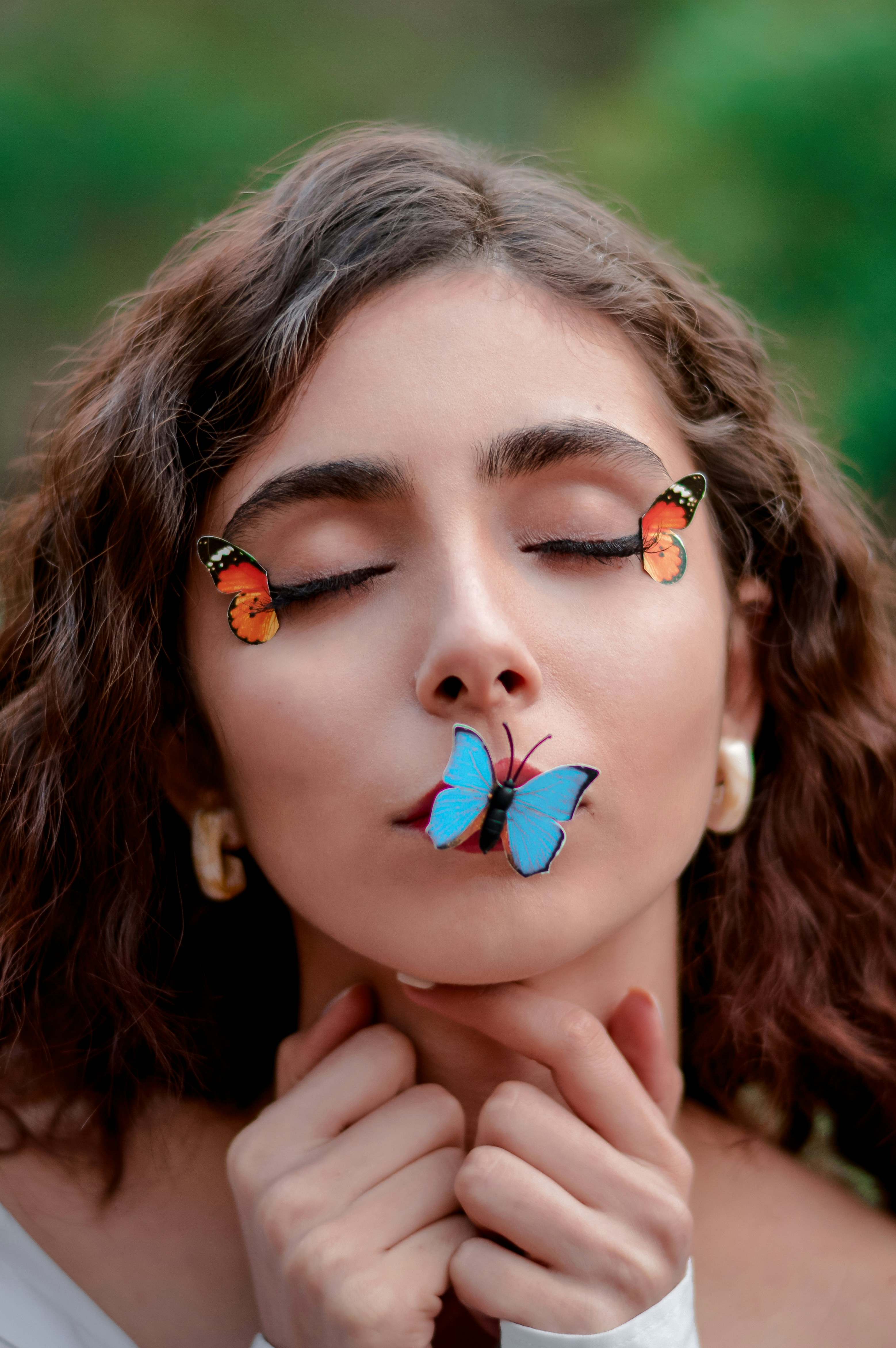 Blue Wing, Quiet Face: A Portrait Framed by Butterflies