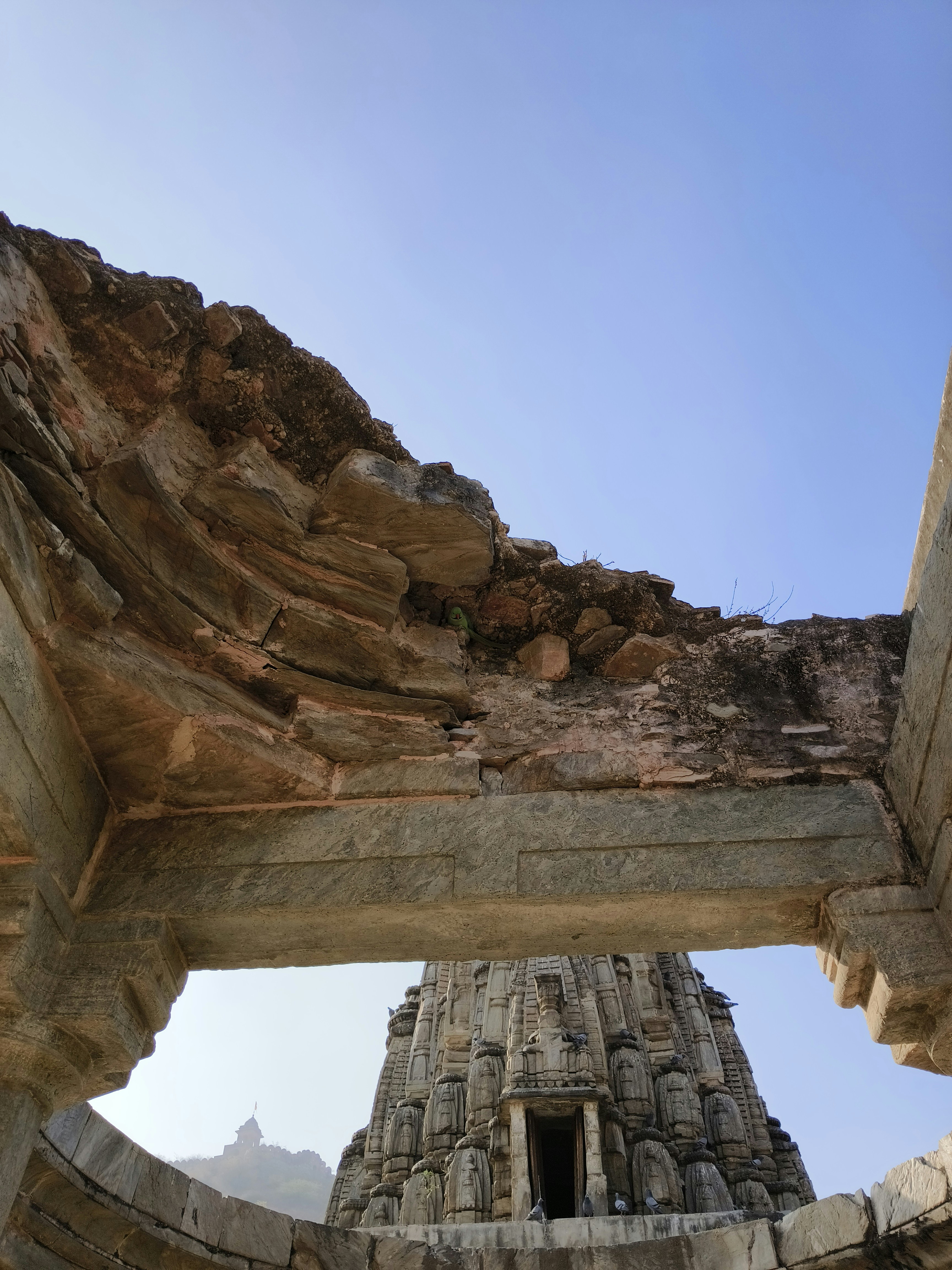 Peering Through Time: A Temple Tower Framed by Ancient Ruins