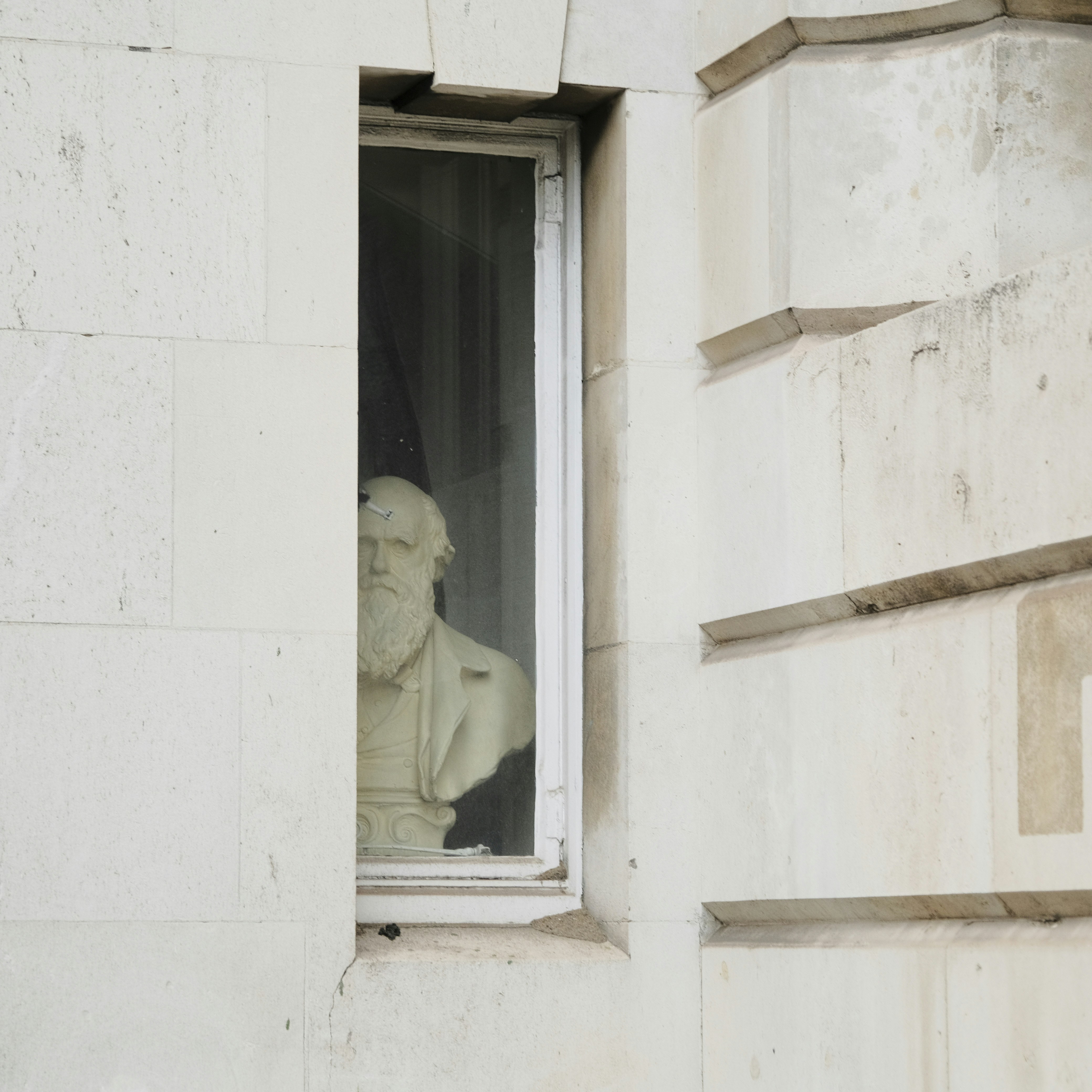 Foto Una estatua de un hombre mirando por una ventana – Imagen Londres ...