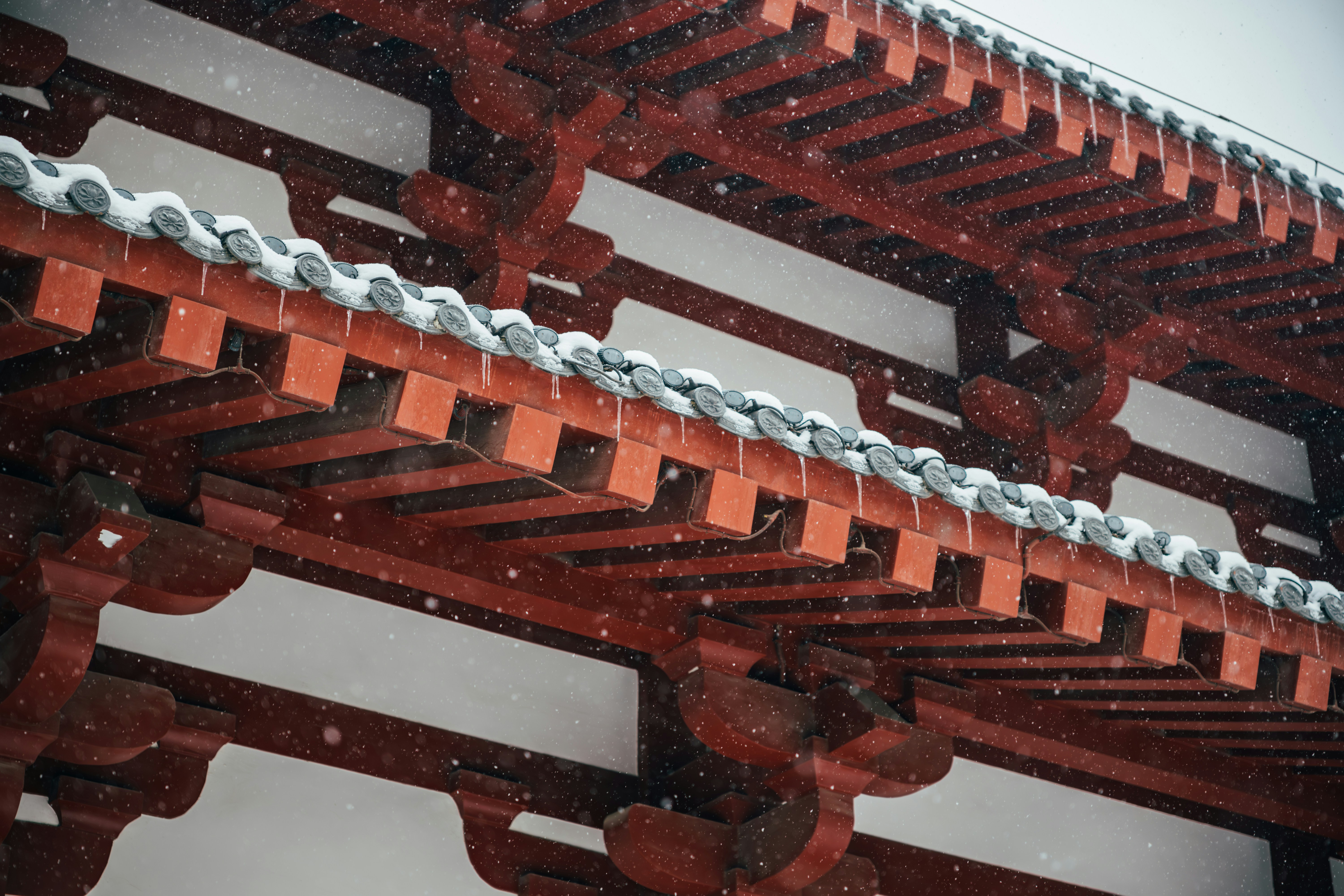 A close up of a building with snow falling on it photo – Free Building ...