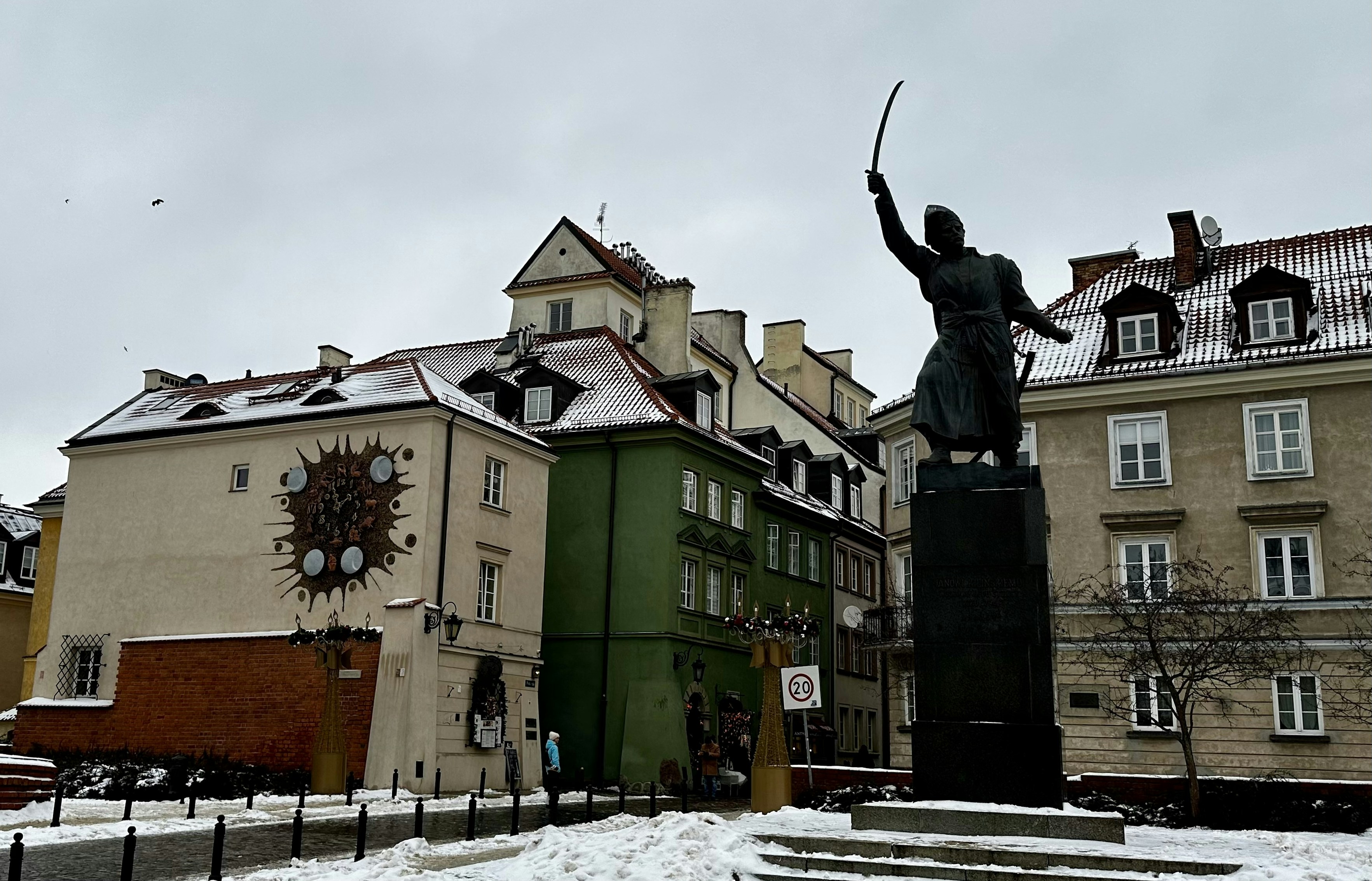 Winter Vigil: Bronze Archer Overlooking a Snow-Dusted Town Square
