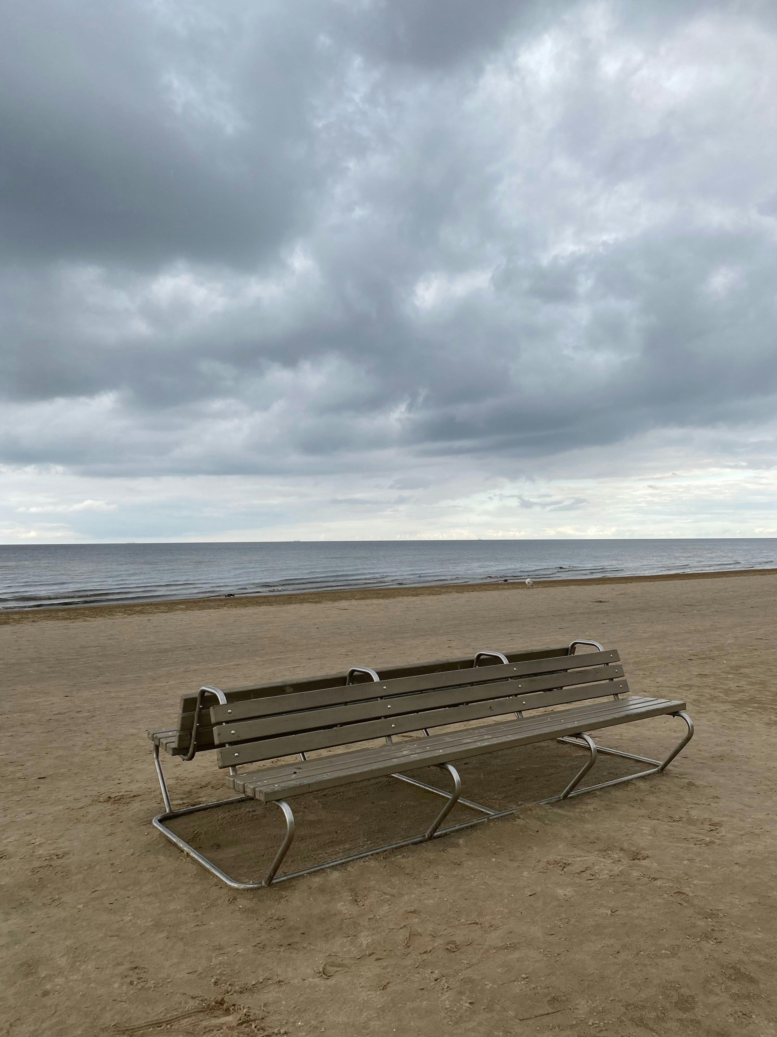 Solitary Bench at the Edge of a Brooding Sea