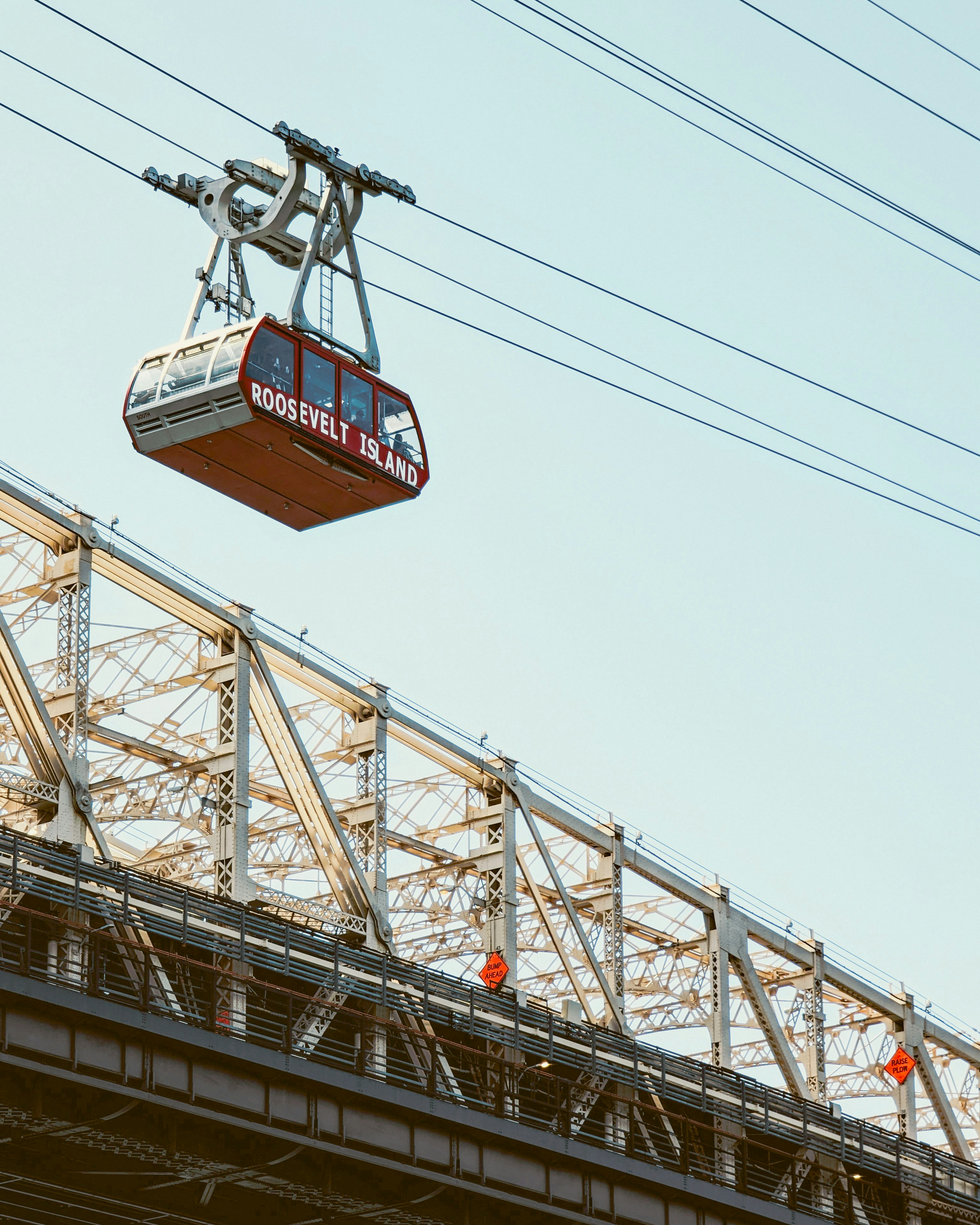 A red and white cable car going over a bridge photo – Free Snow Image ...