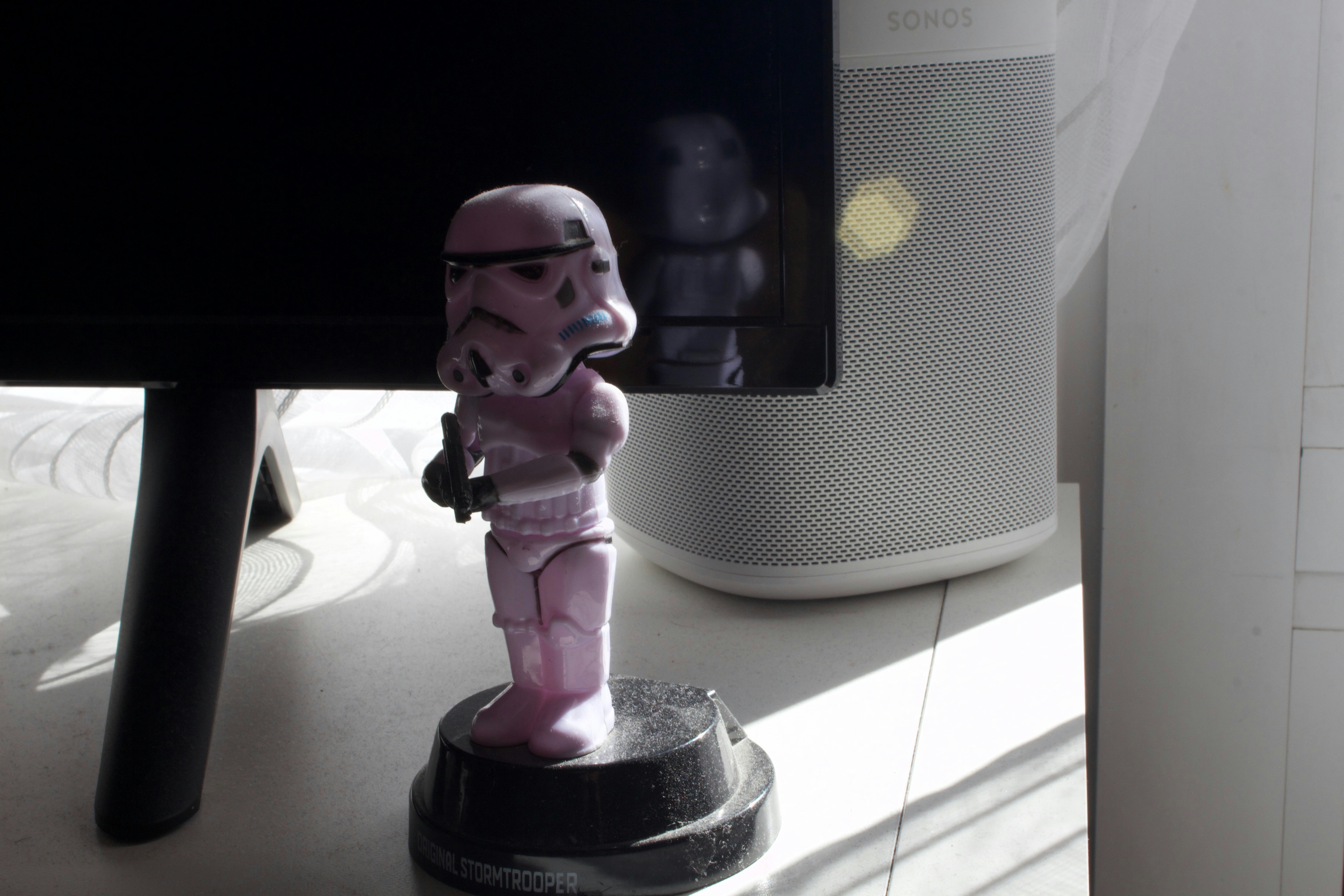 A star wars figurine is posed next to a computer monitor photo – Free ...