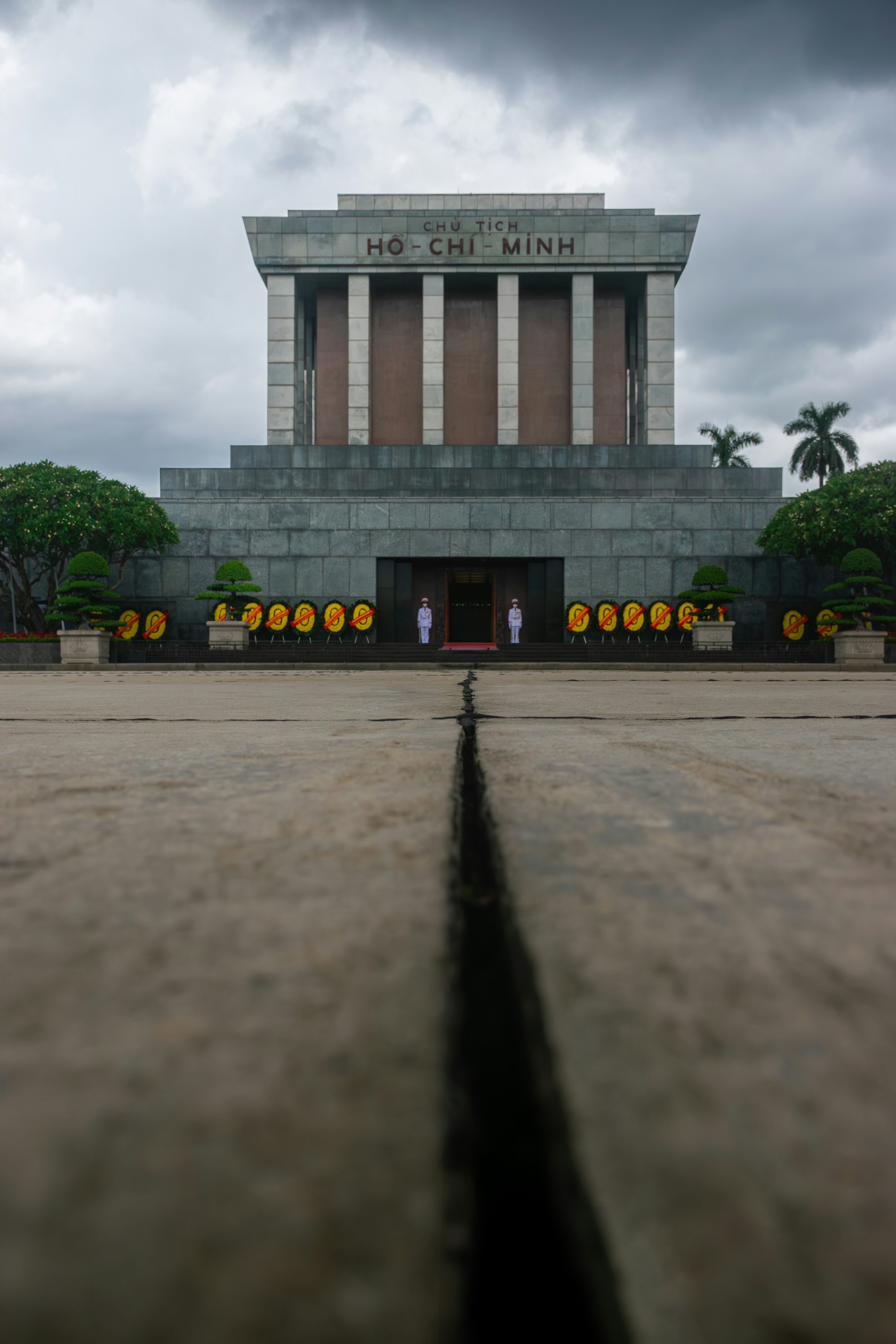 Low angle leading line view of Ho Chi Minh's Mausoleum on a cloudy day. Hanoi, Vietnam, Aug/22.