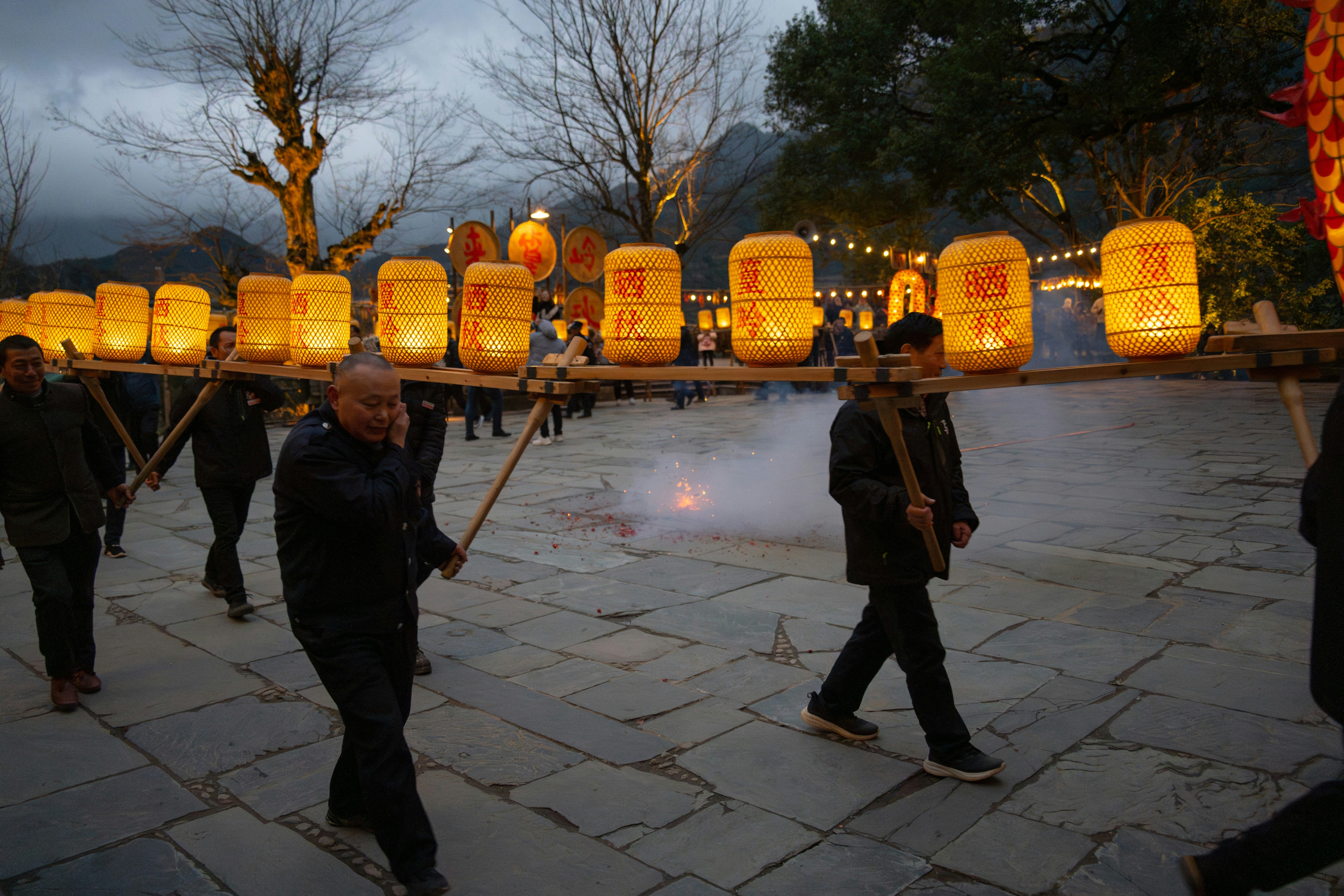 Lantern-lit Procession: Carriers of Light Through Evening Stone Plaza