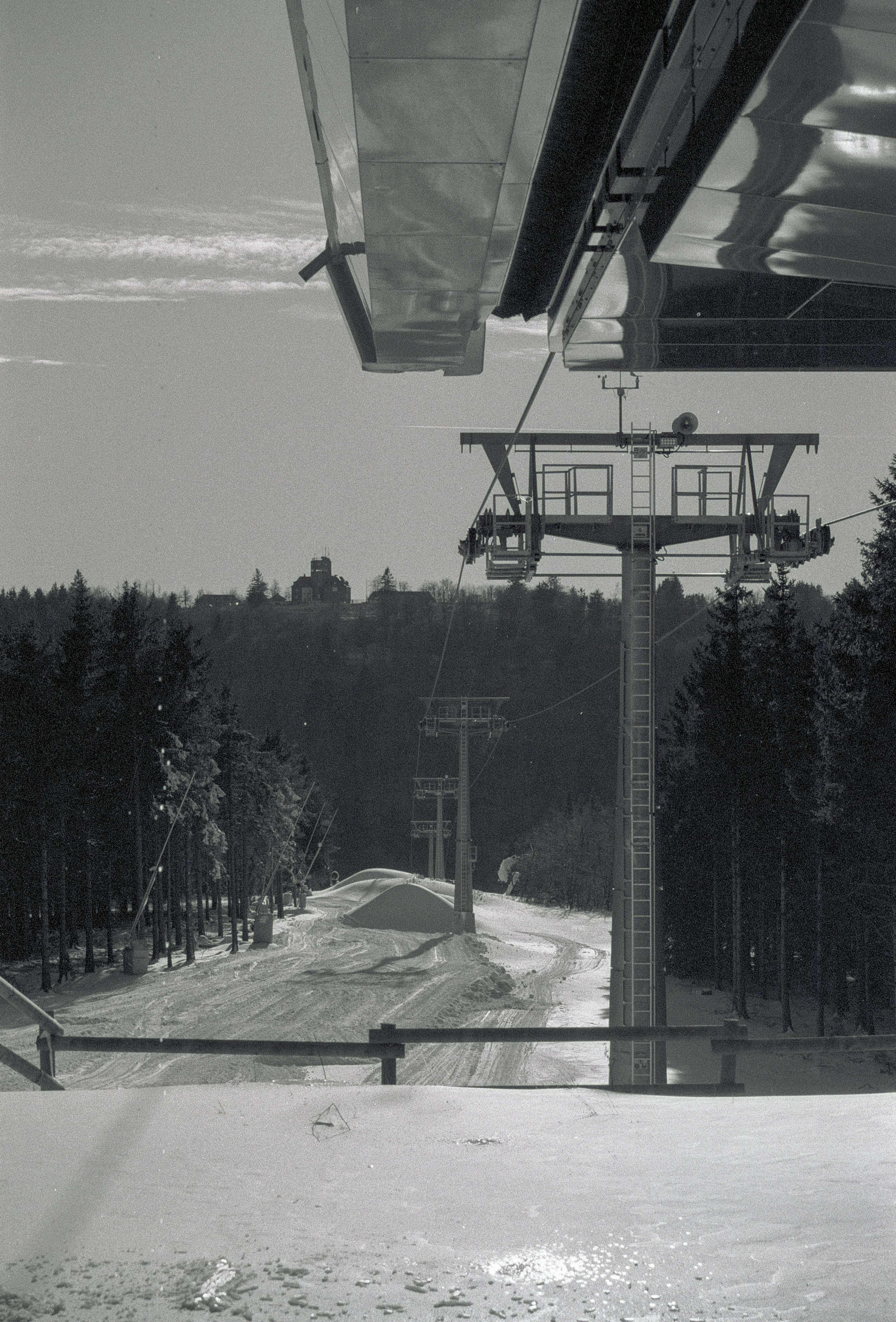 Vertical Silence: Snow-Laced Lift Towers Rise Over a Narrow Horizon