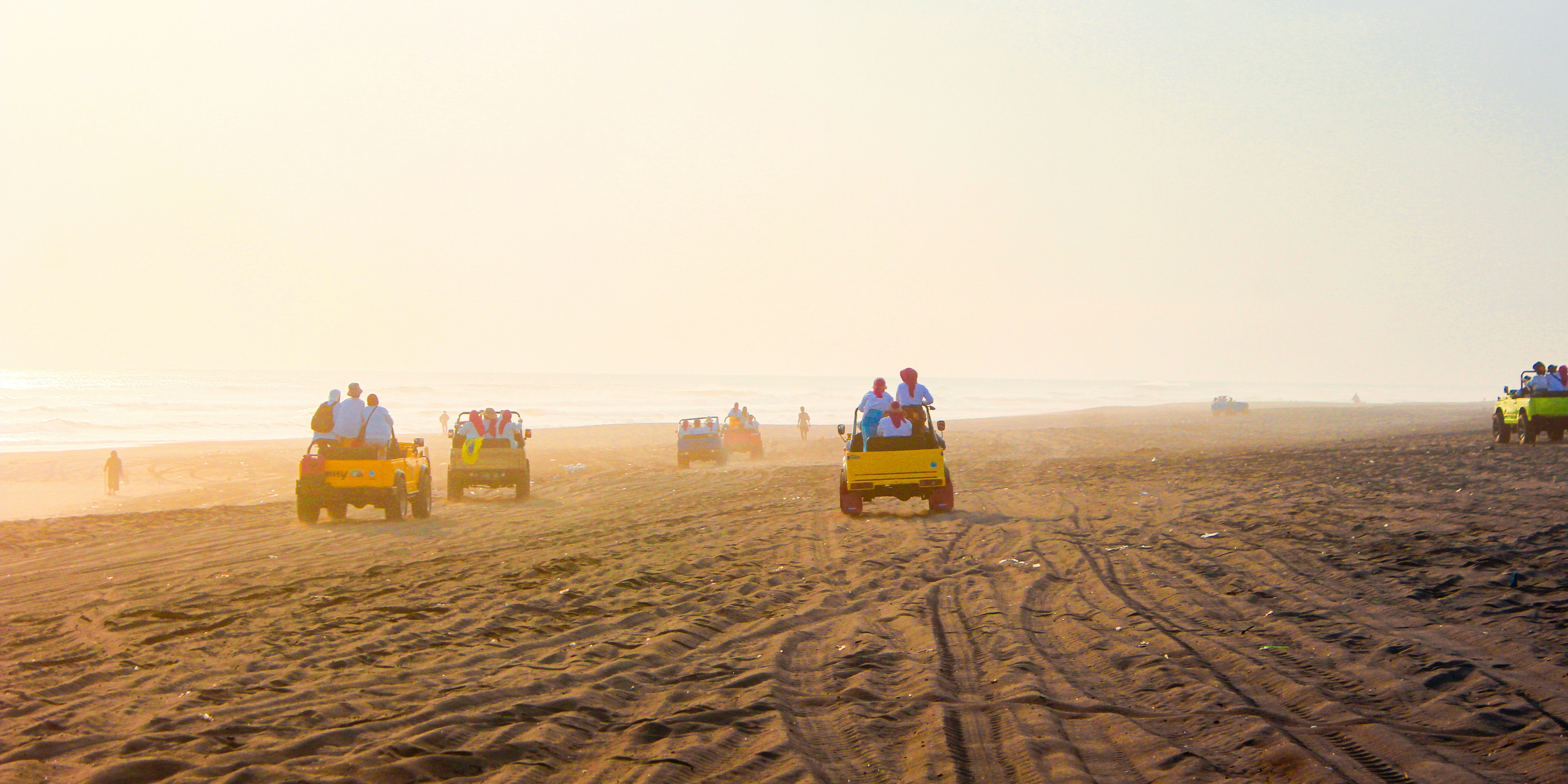 A group of people riding on the back of four wheelers photo – Free ...