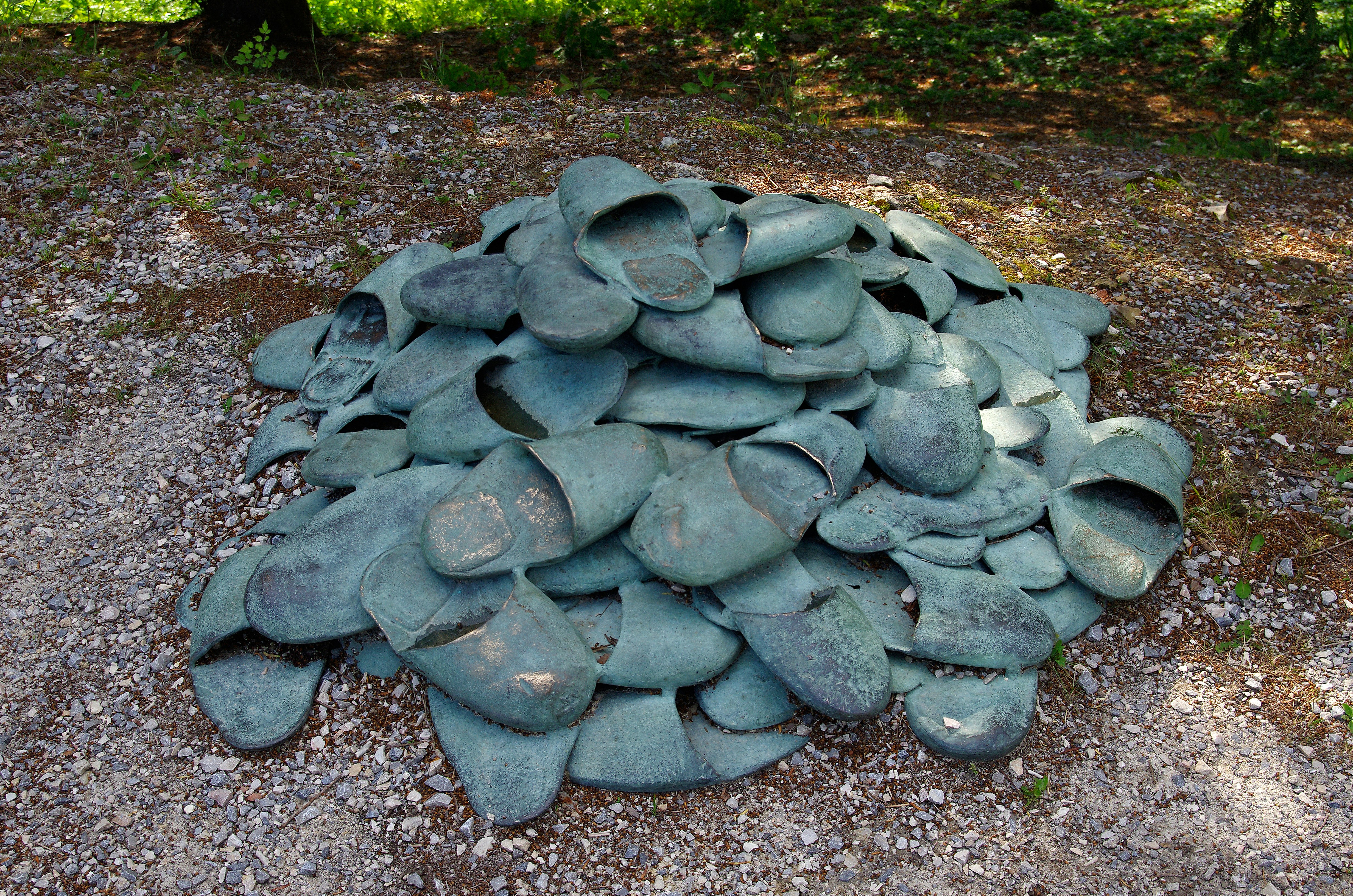 Blue-Green Slate Disc Stack on Gravel: A Quiet Outdoor Still-Life