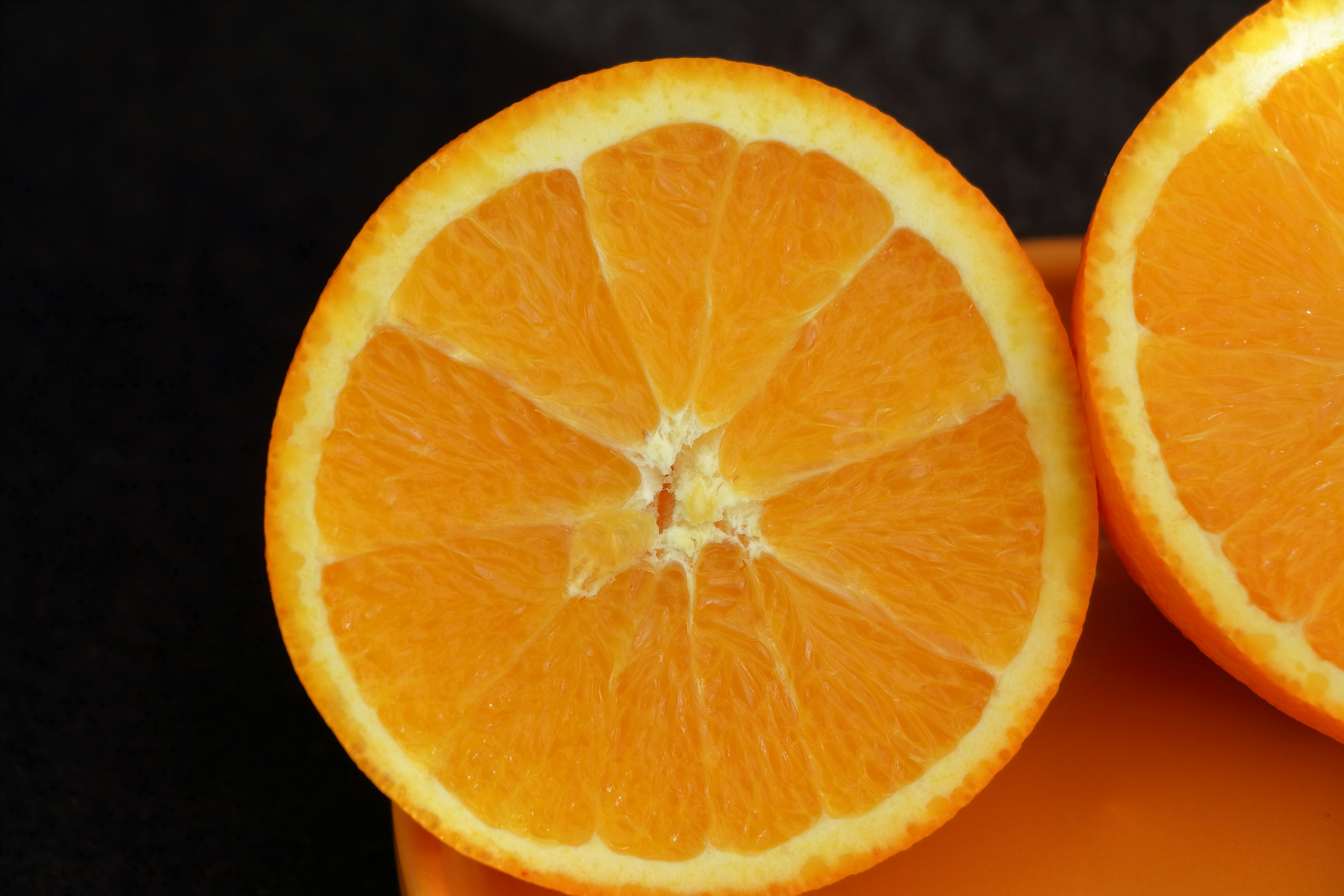 A close up of two halves of an orange photo – Free Orange Image on Unsplash