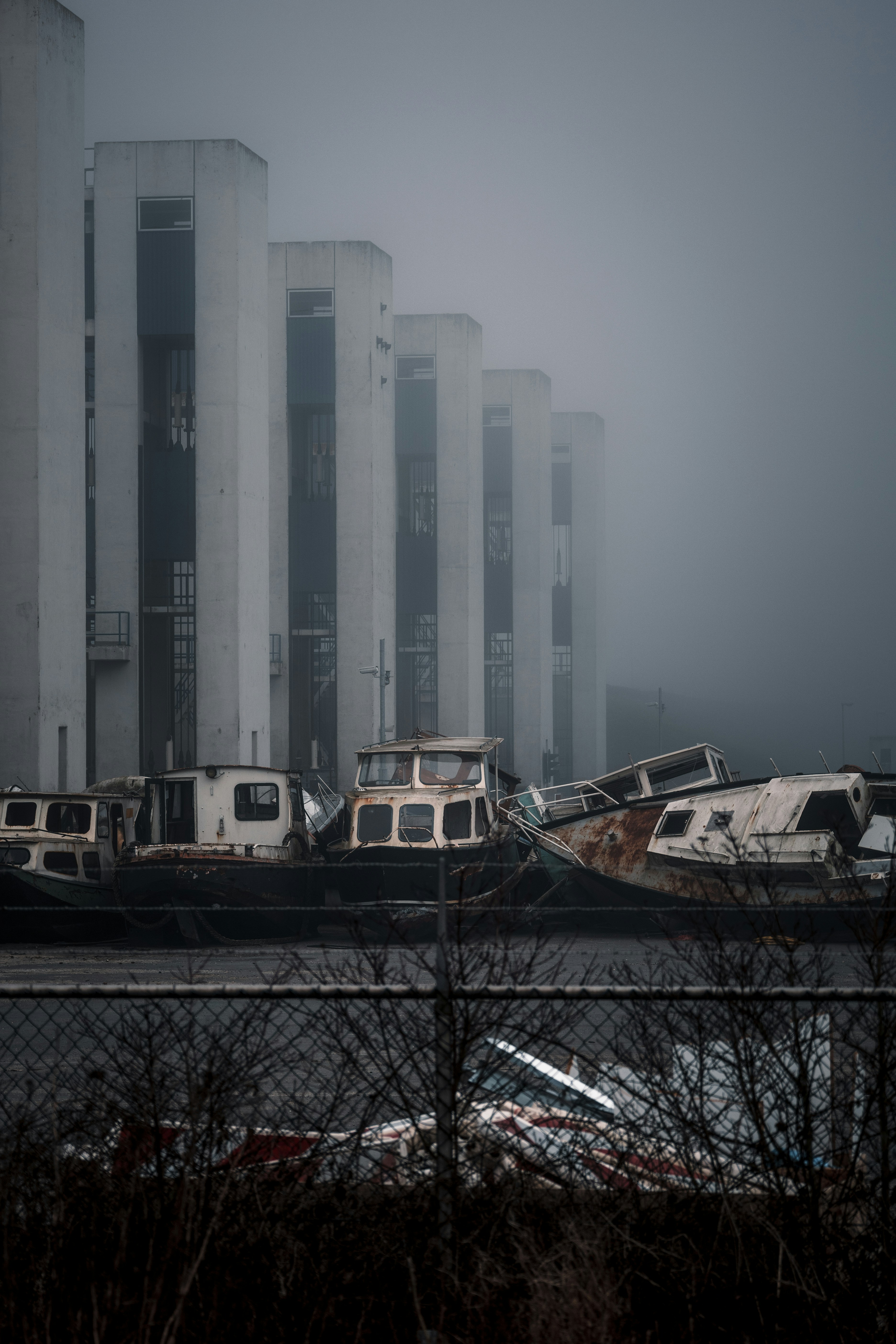 Fogbound Vessels Beside Monolithic Pylons