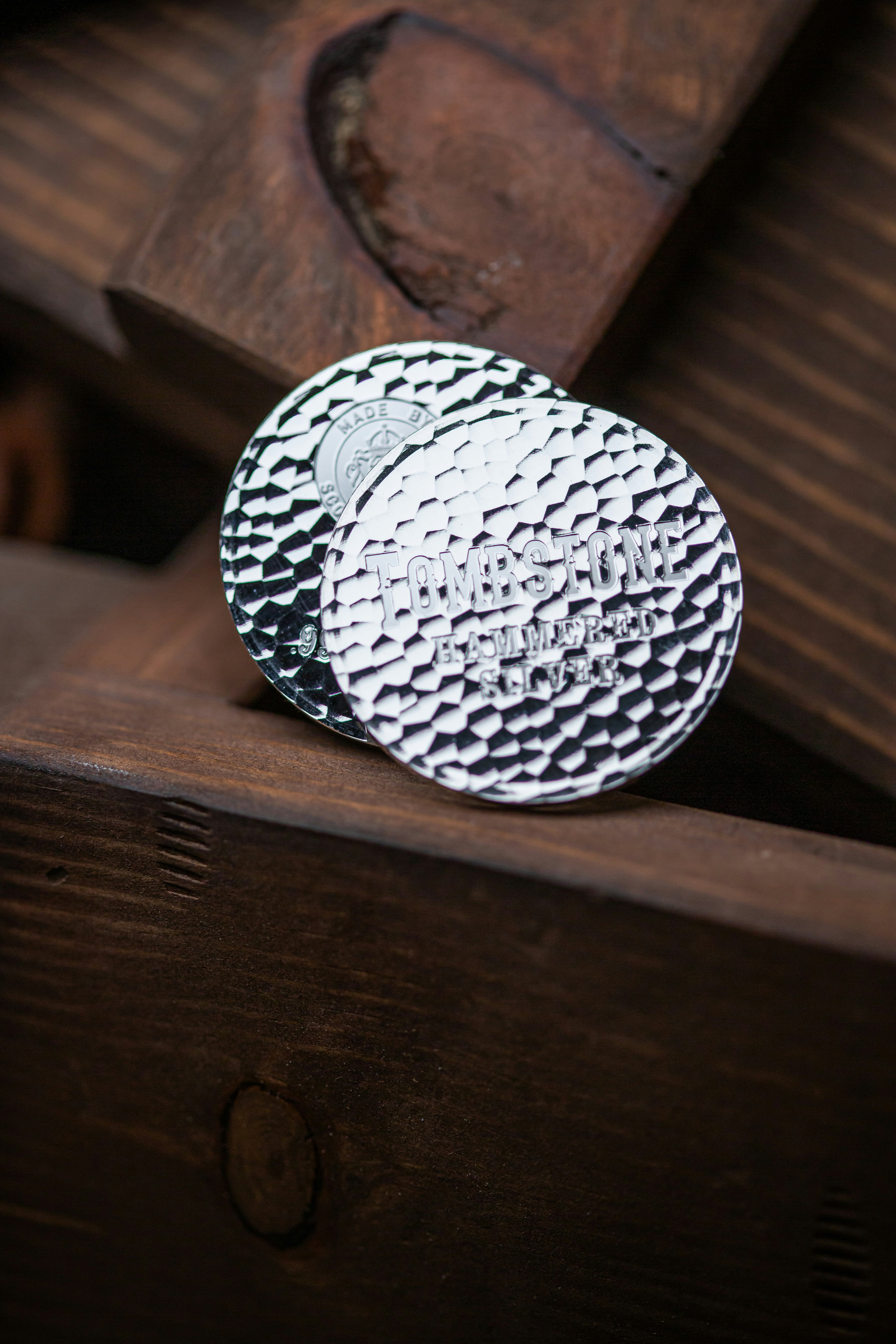 Tombstone Silver Round made by Scottsdale Mint sitting on a wooden antique box.
