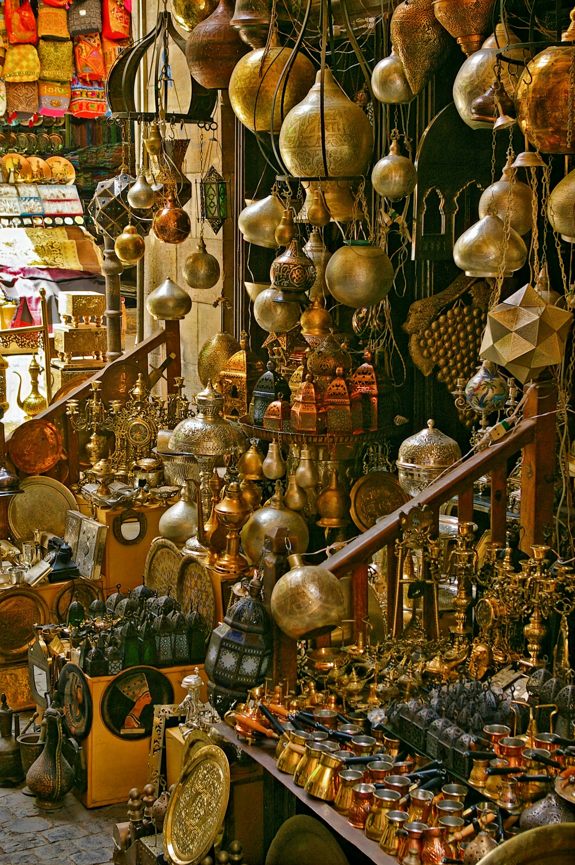 An intricate display of brass and copper artifacts in a bustling market, showcasing the rich heritage of local craftsmanship.