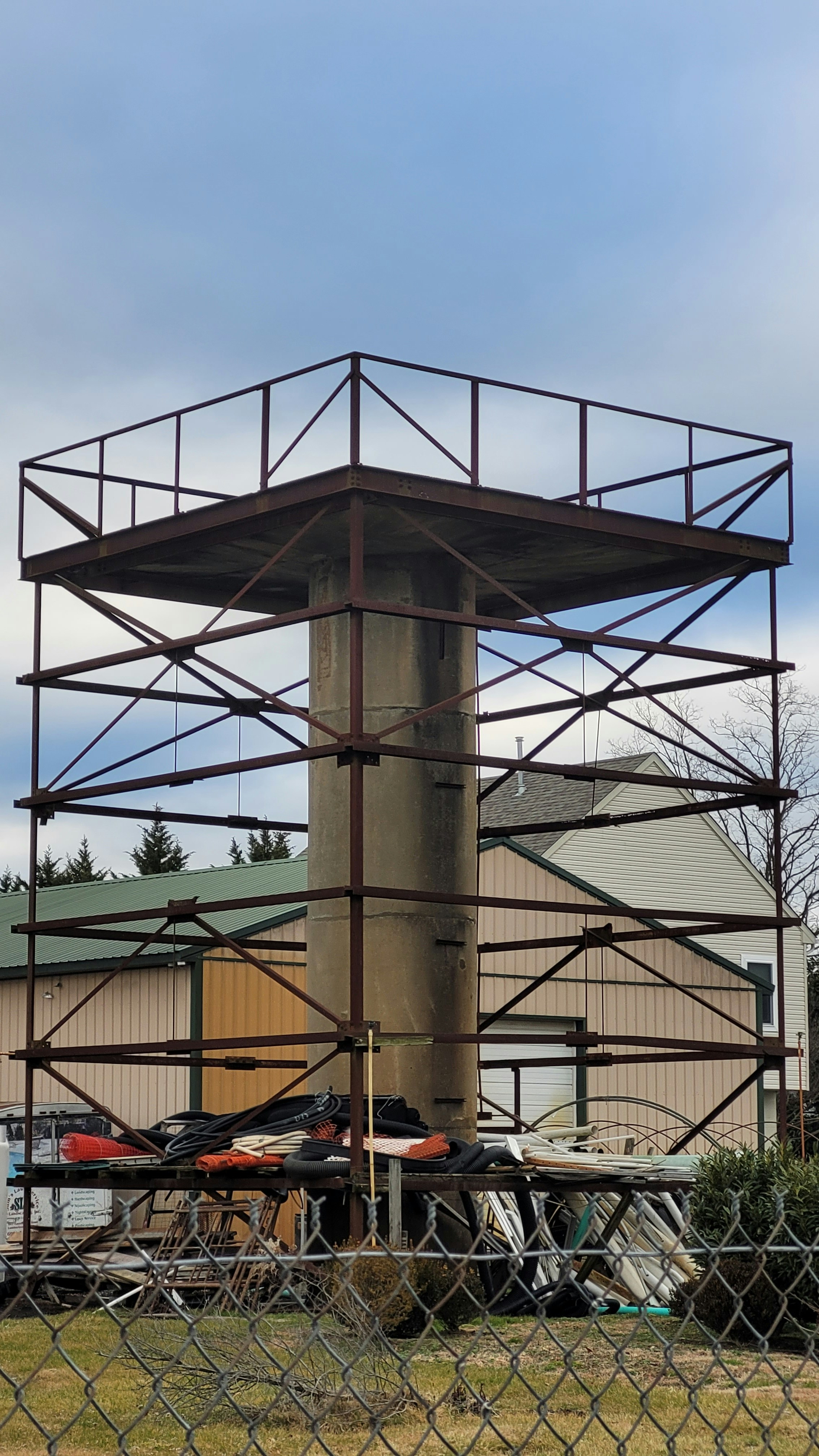 Rust and Rigging: Central Pillar Framed by a Latticed Tower